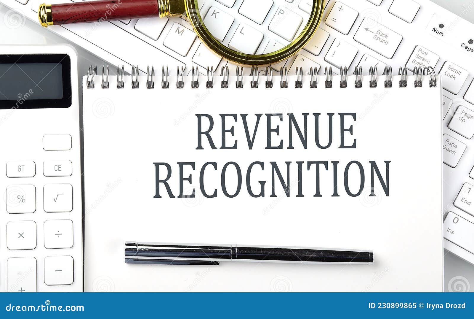 REVENUE RECOGNITION . Text on Notepad with Calculator and Keyboard ...