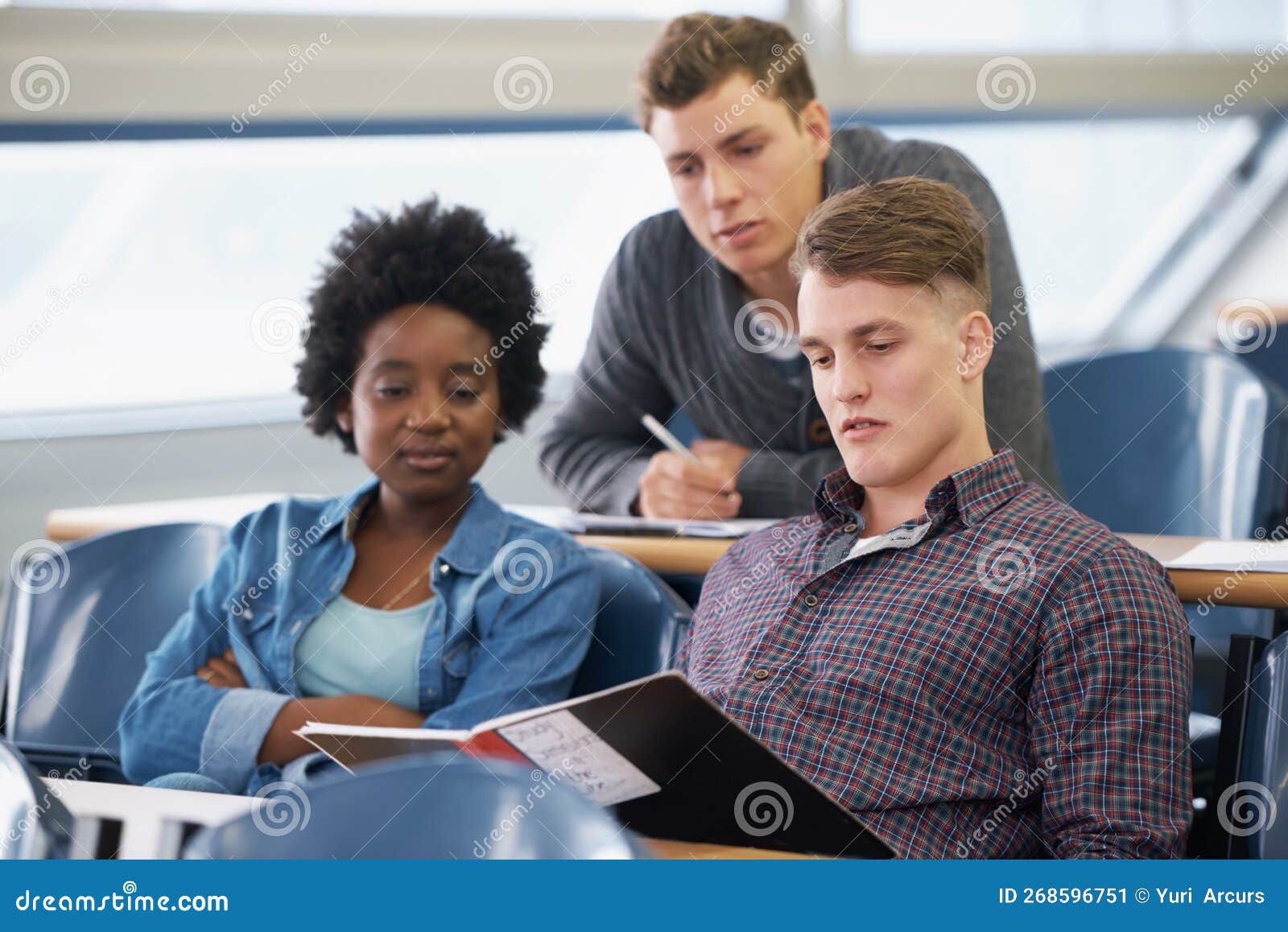 Revision. a Group of Students Sitting in Class Going Over Their ...