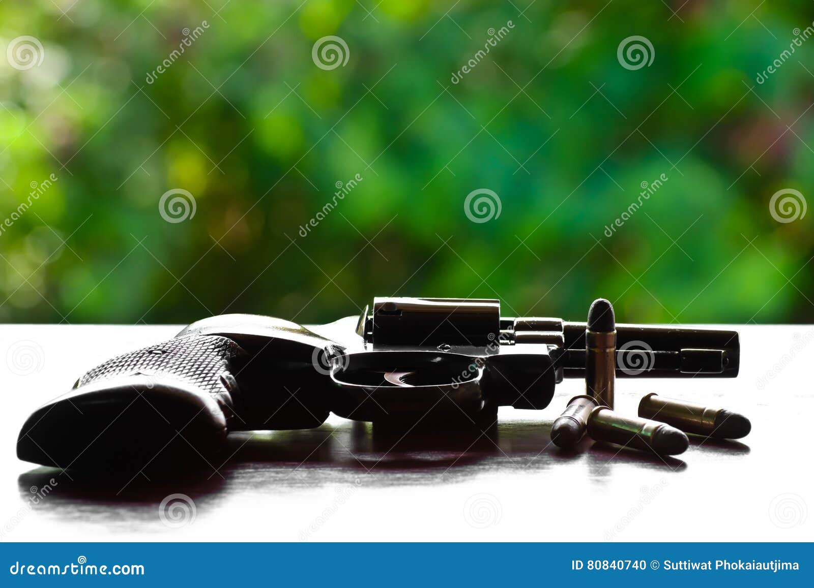 Revolver with Bullets on the Table Stock Photo - Image of holding ...