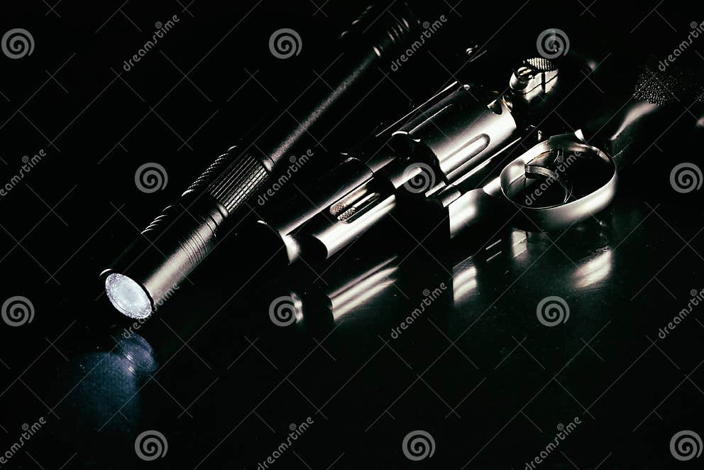 Revolver and Flashlight on a Black Stock Photo - Image of danger ...