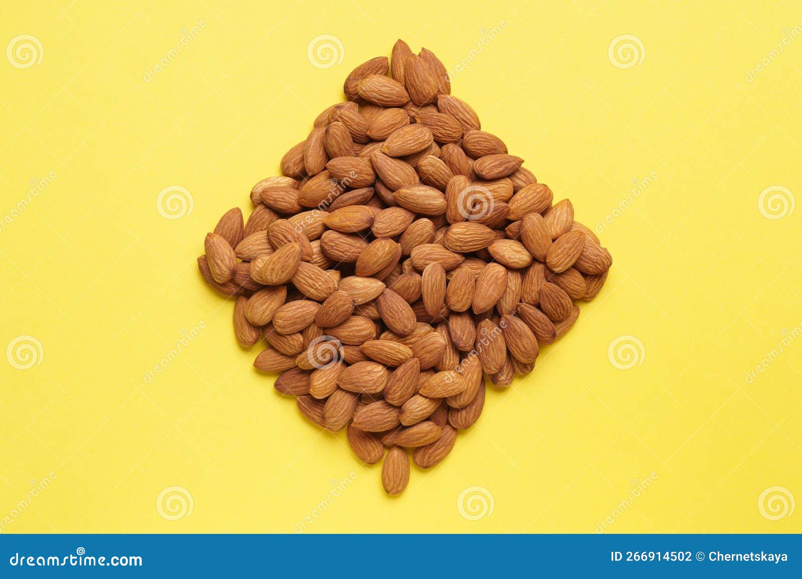Rhombus Made of Delicious Raw Almonds on Yellow Background, Flat Lay ...