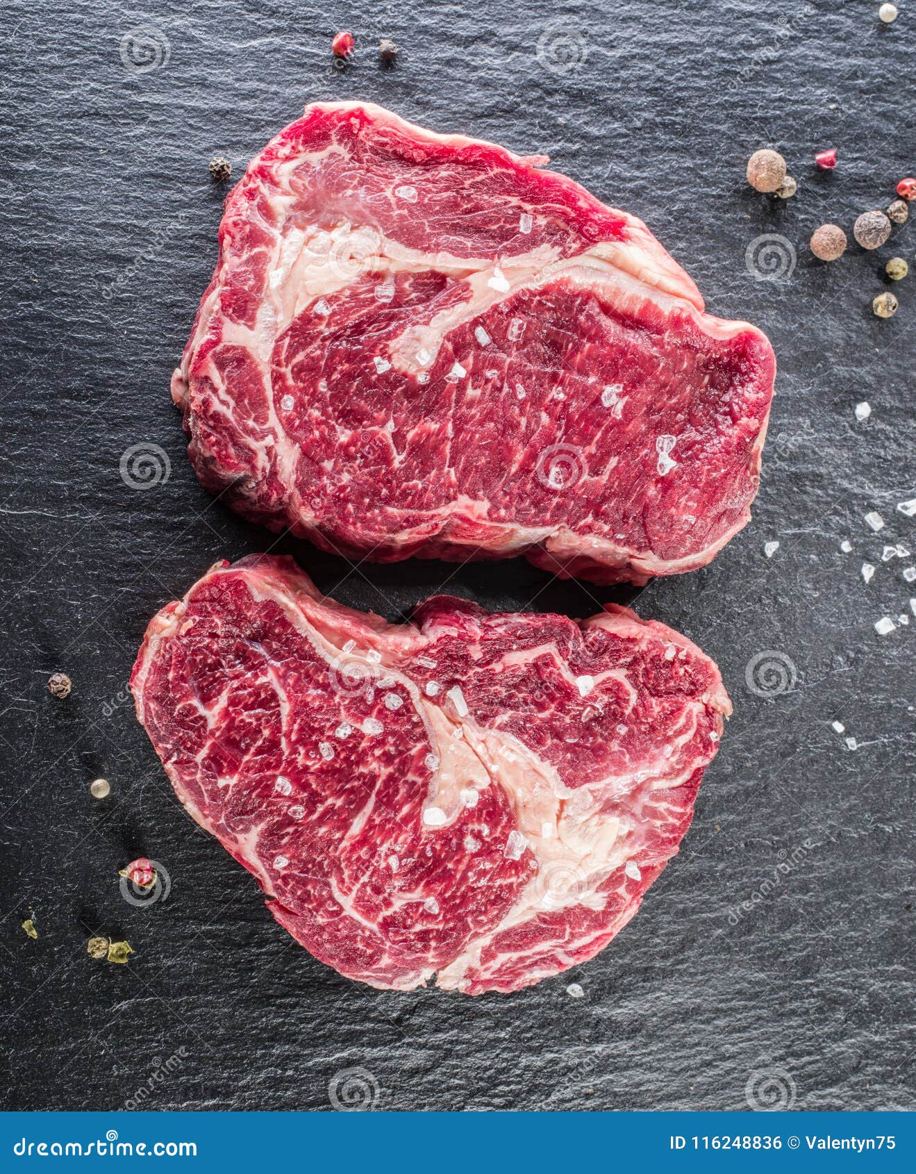 Rib Eye Steaks with Spices on the Black Background. Stock Photo - Image ...