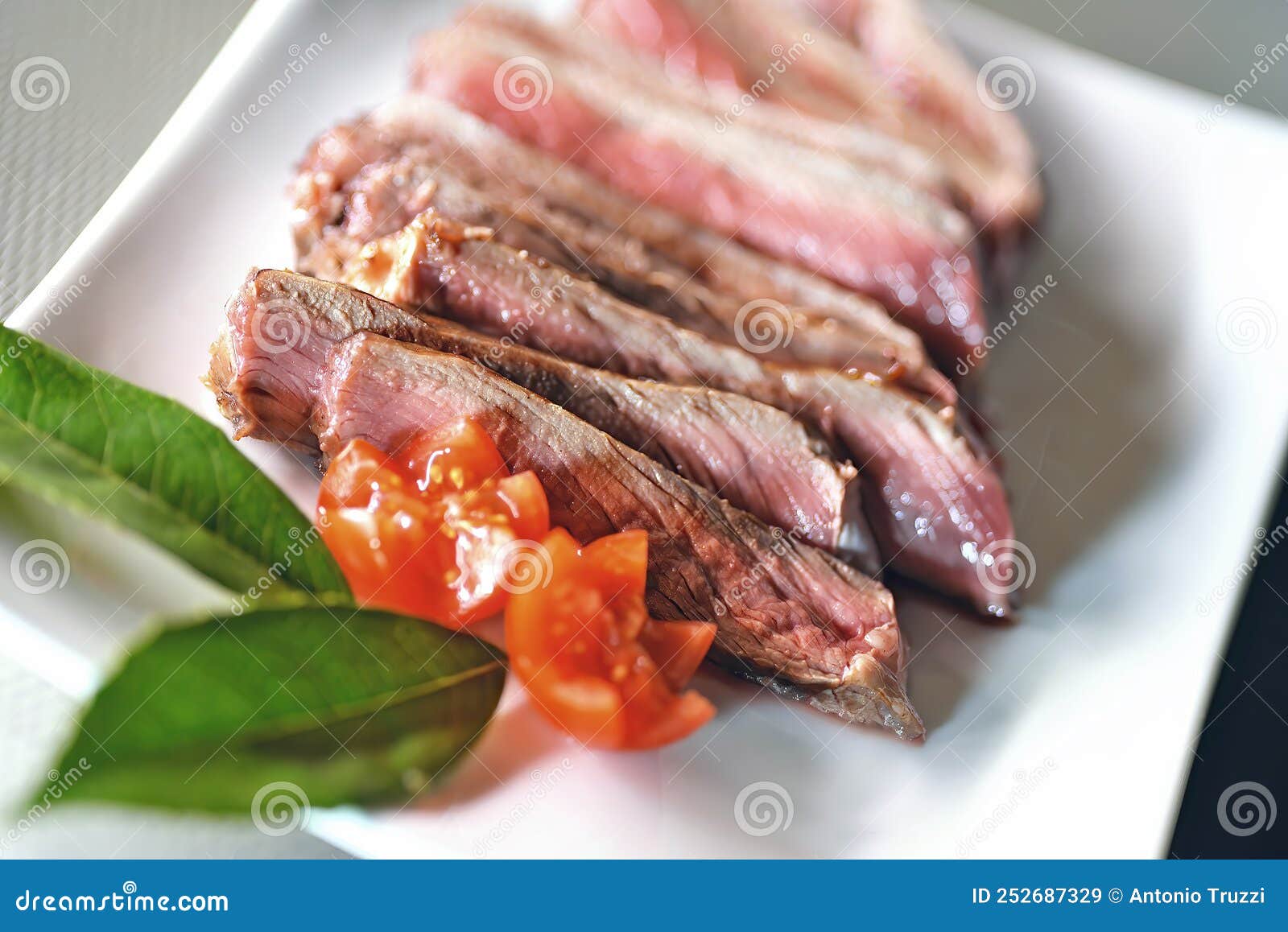 Ribeye Steak on the Bone Sliced in a Rectangular Dish Stock Image ...