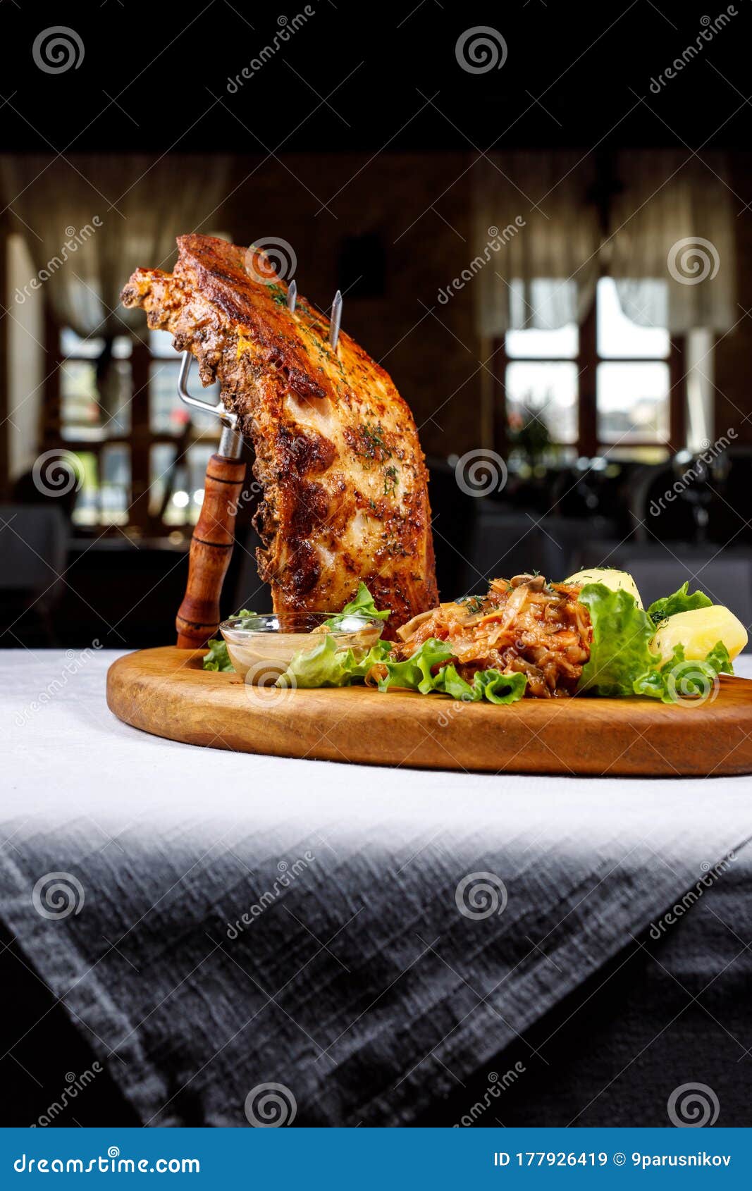 Ribs on a Fork with a Side Dish of Vegetables in a Restaurant Interior ...