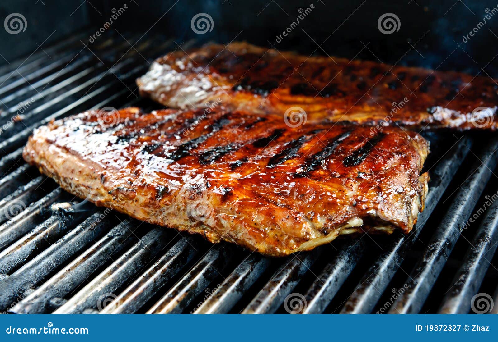 Ribs on the grill stock image. Image of fire, delicious - 19372327