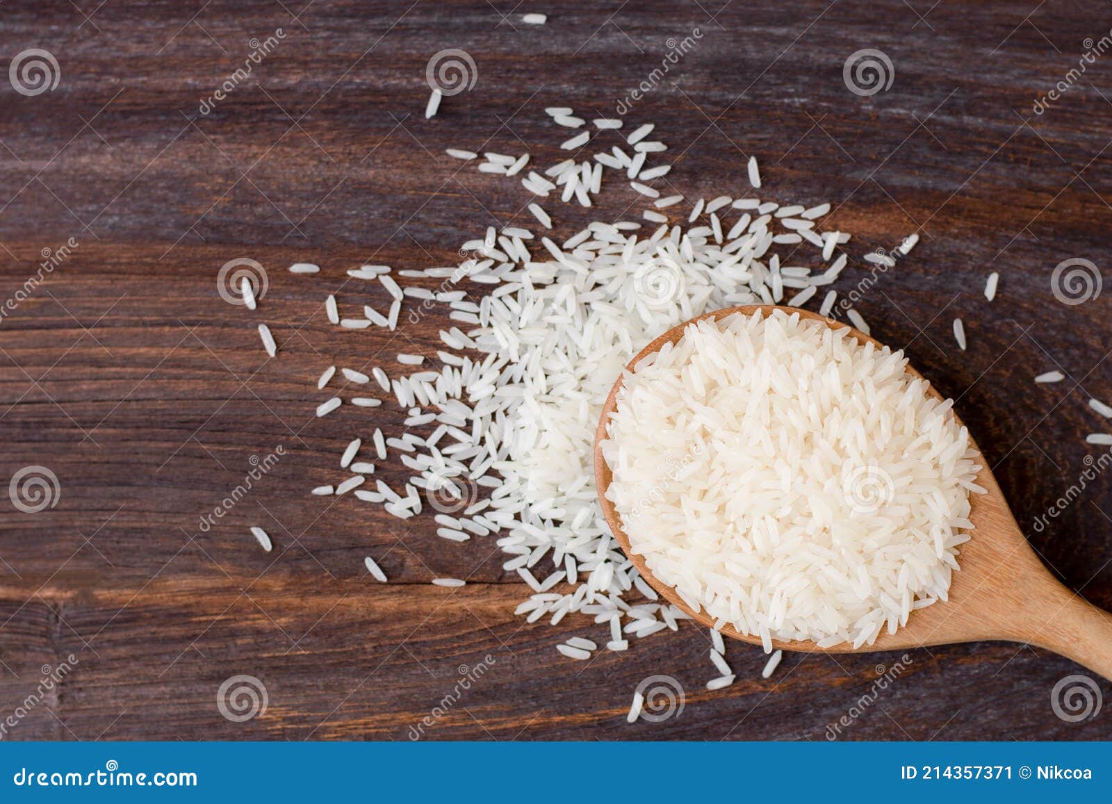 White rice on wood table stock image. Image of isolated - 214357371
