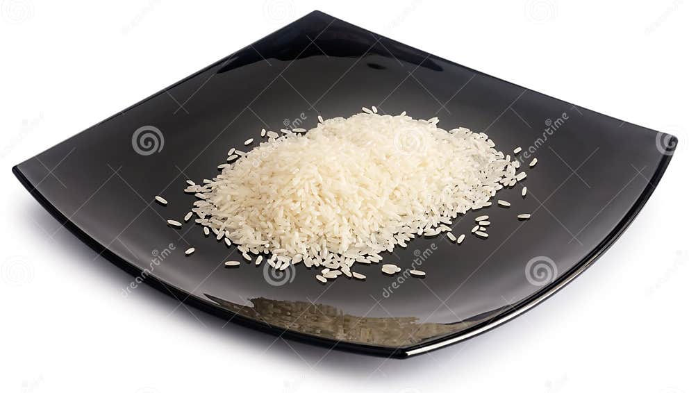 Rice on black plate stock photo. Image of black, surface - 10933688