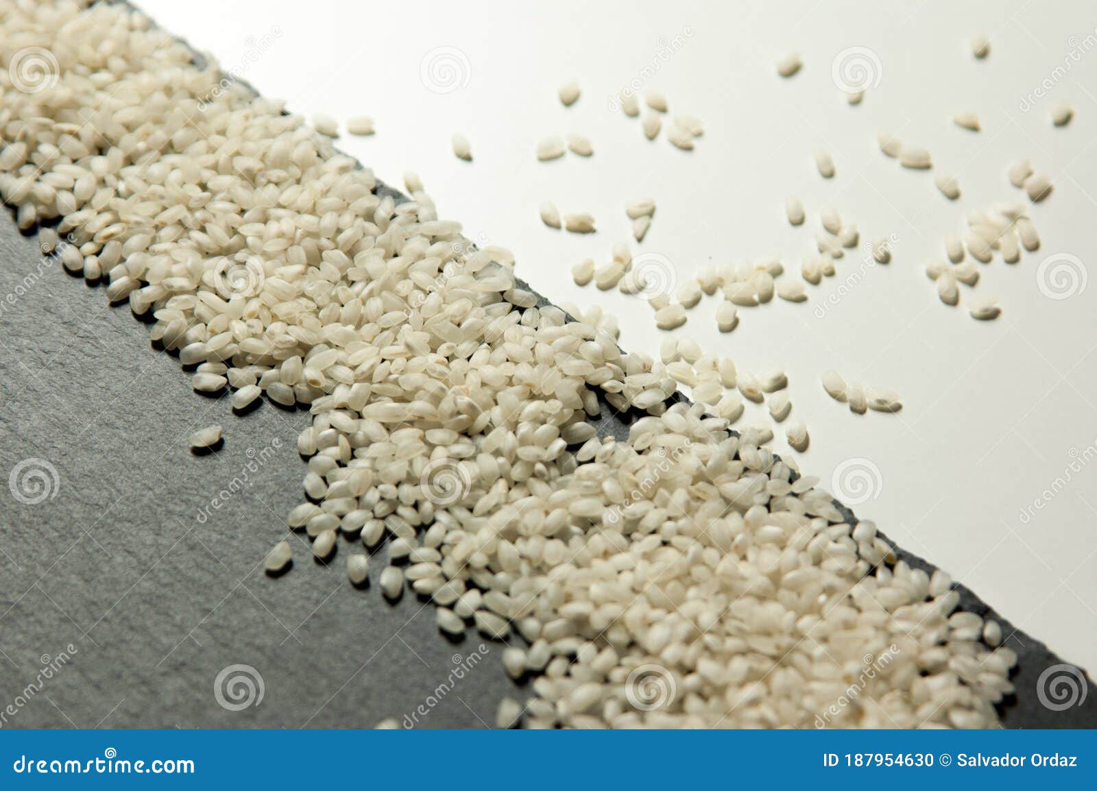 Rice on black slate stone stock photo. Image of cooked - 187954630
