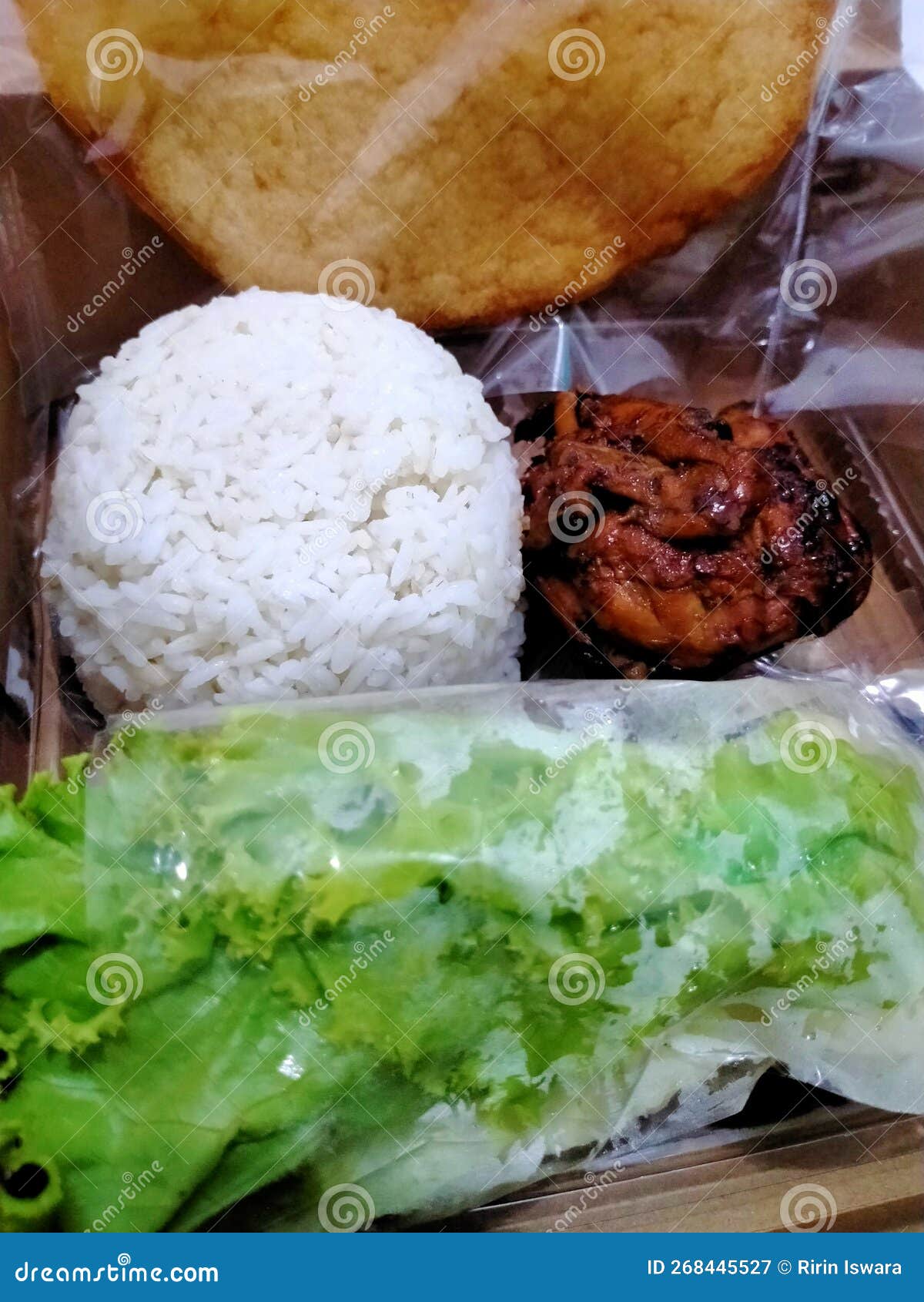 Rice Box with Side Dishes of Chicken, Vegetables and Crackers Stock ...