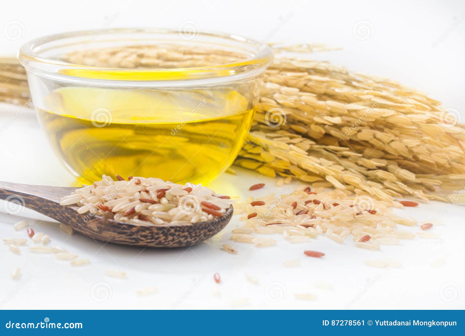 Rice Bran Oil In Bottle Glass And Unmilled Rice On Wooden Background ...