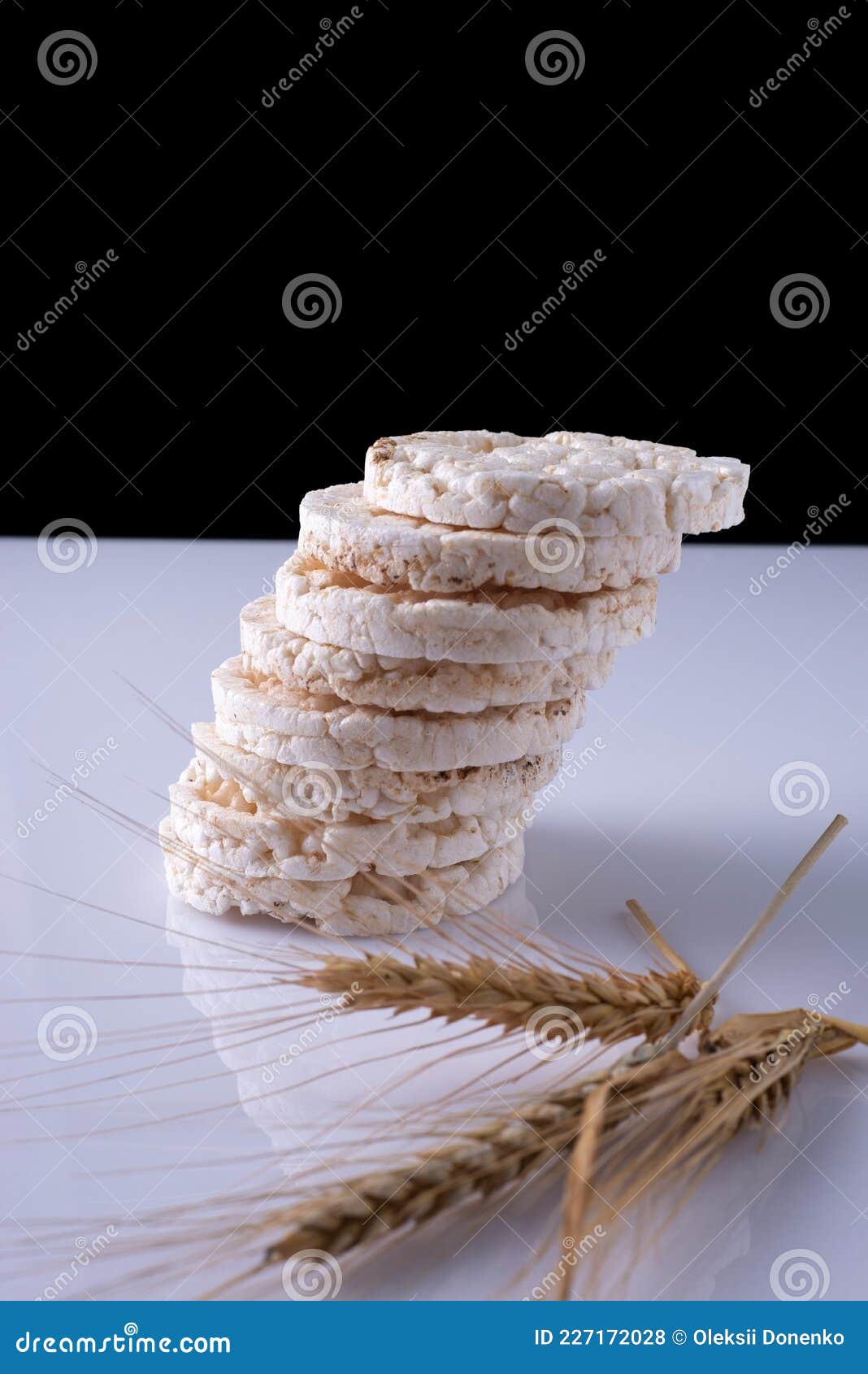 Rice Cakes with Wheat Ears on White Table and Black Background Stock ...