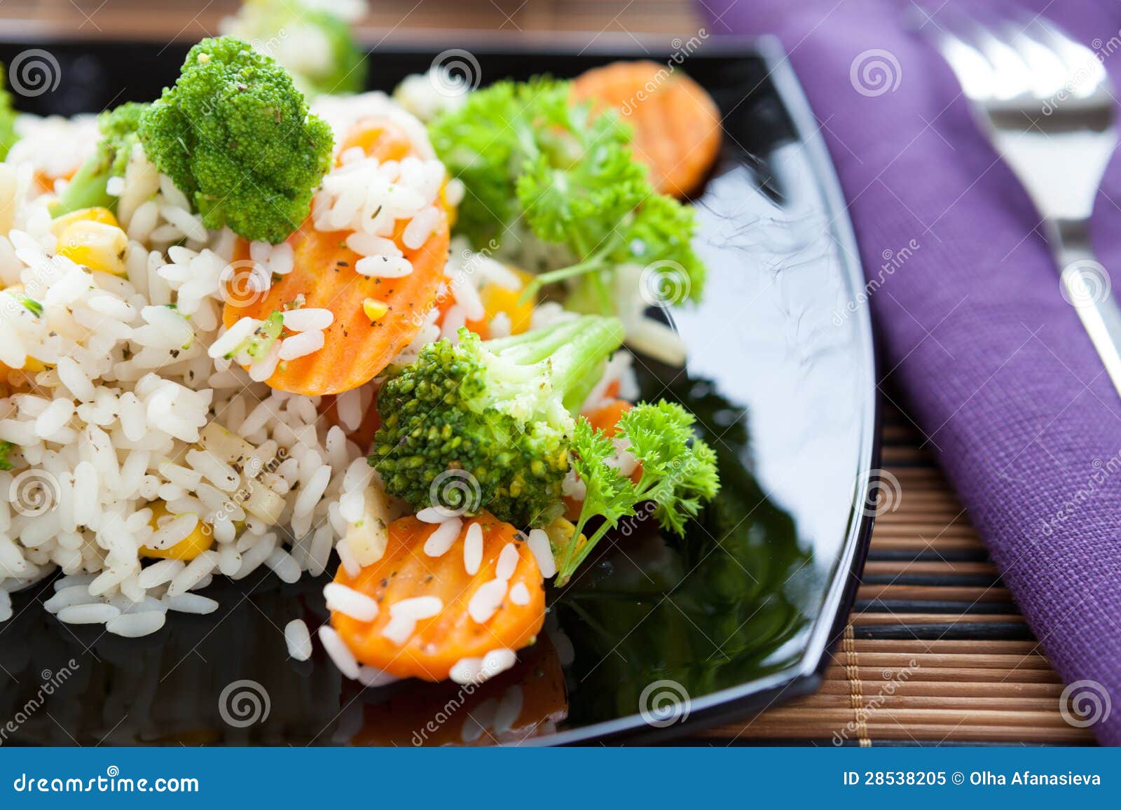 Rice with Carrots and Broccoli on a Black Plate Stock Image - Image of ...