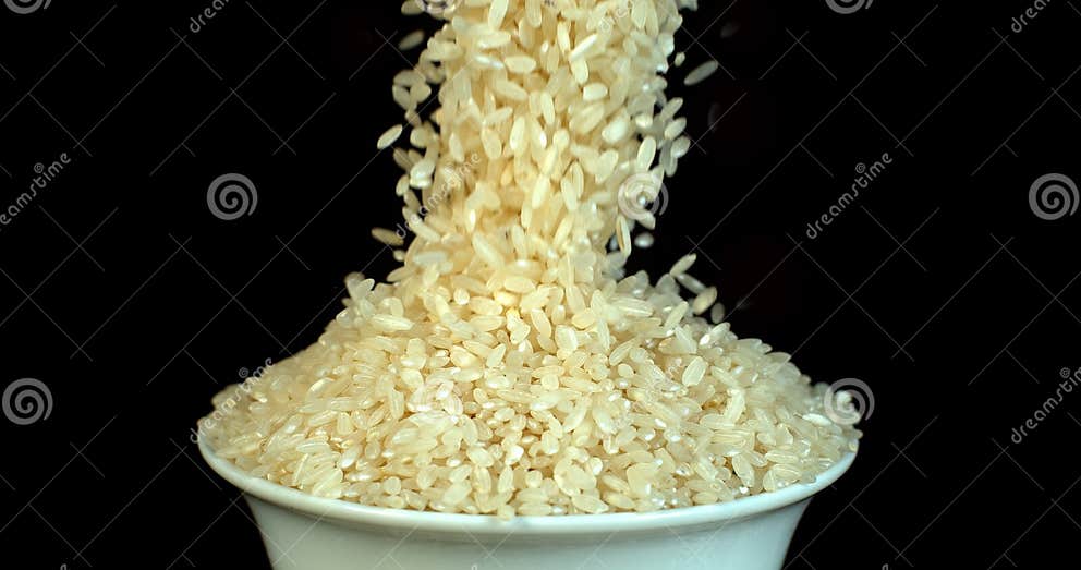 Rice Falling Against Black Background Stock Image - Image of diet ...