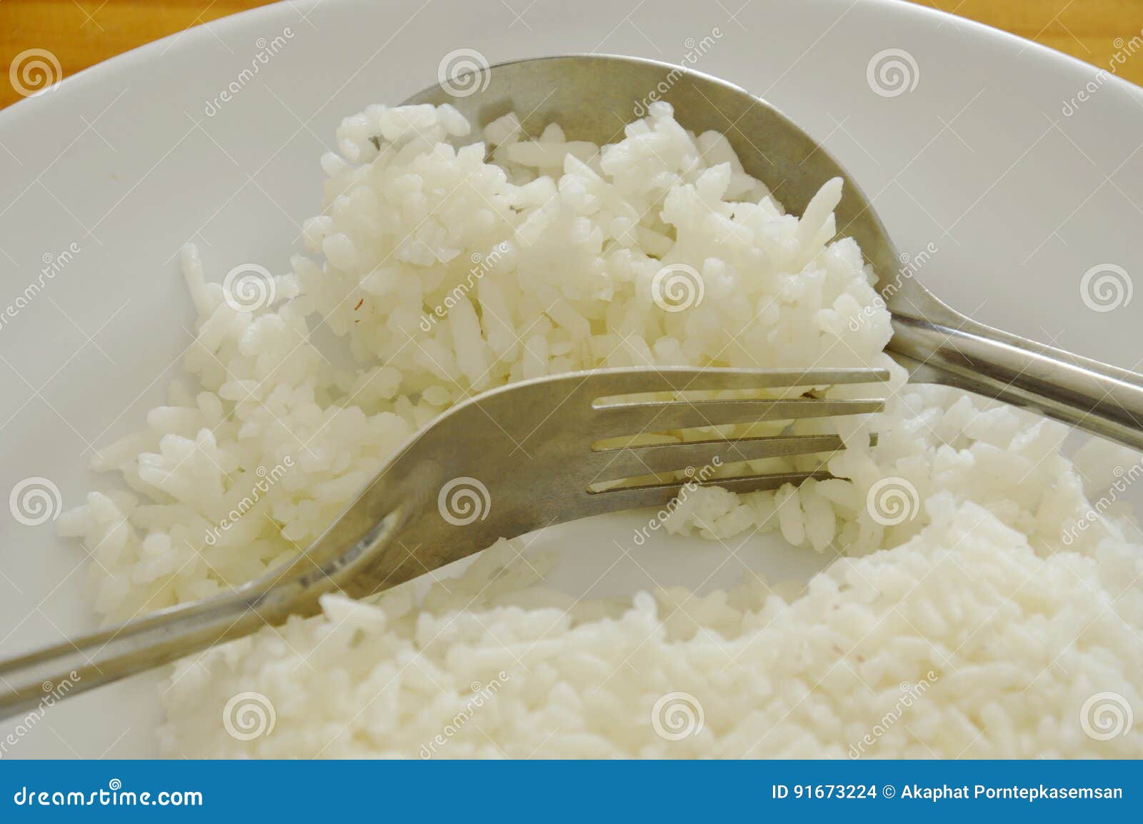 Rice Scooping by Spoon and Fork from Plate for Eating Stock Photo ...