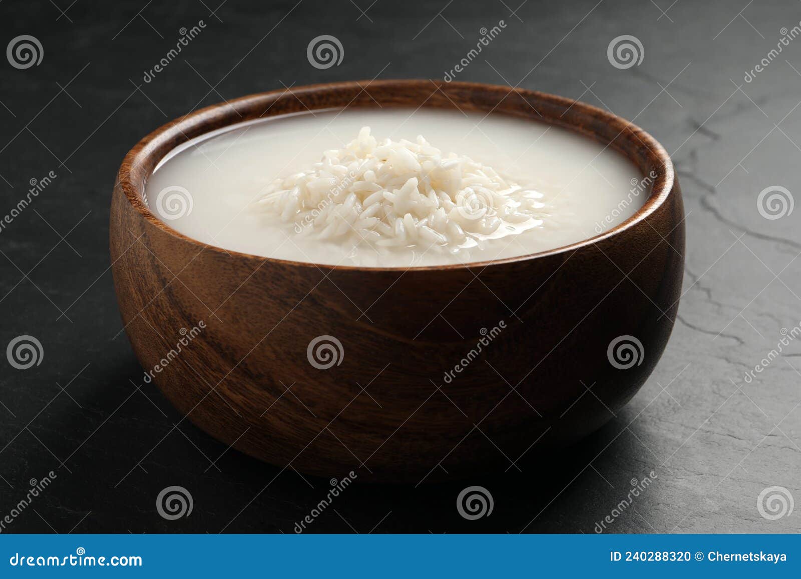 Rice Soaked in Water on Black Table, Closeup Stock Photo - Image of ...