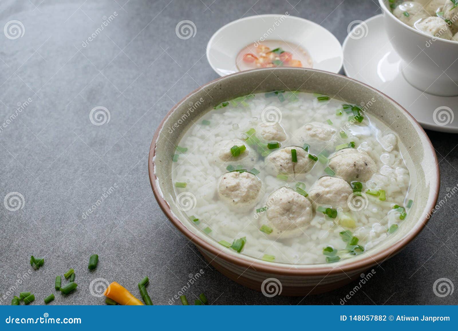 Rice Soup with Chicken Ball and Scallion in Gray Bowl on Table Stock ...