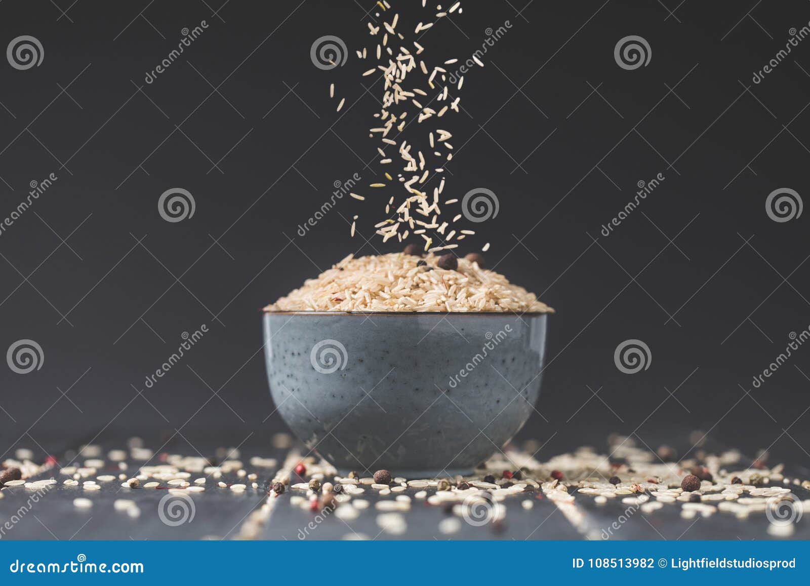 Rice Spilling into Bowl on Black Table Stock Photo - Image of eating ...