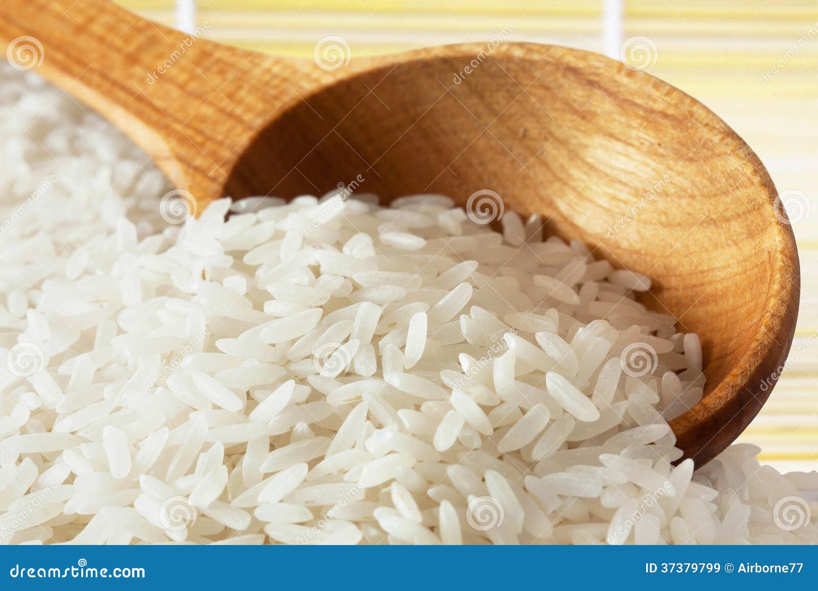 Rice on wooden spoon stock image. Image of dietary, heap - 37379799