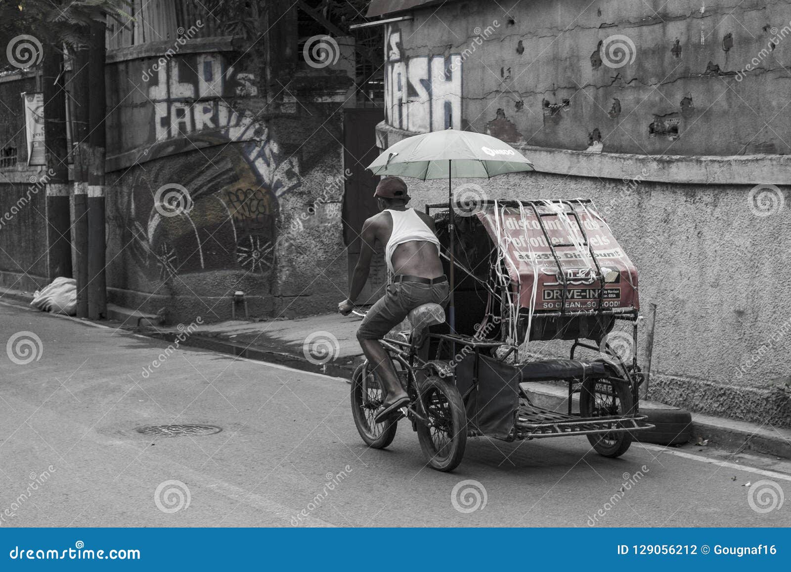 Rickshaw Driver Rides Away in an Empty Street of Manila, the ...