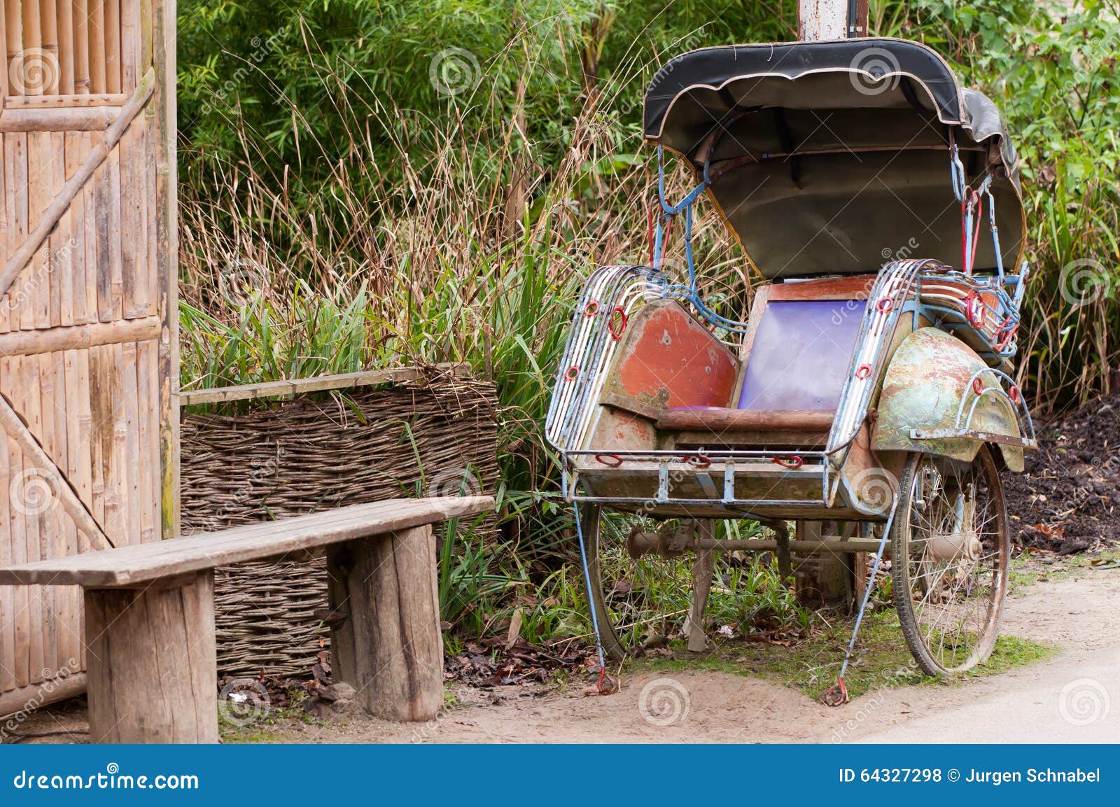 Rickshaw next to a bench stock photo. Image of transport - 64327298