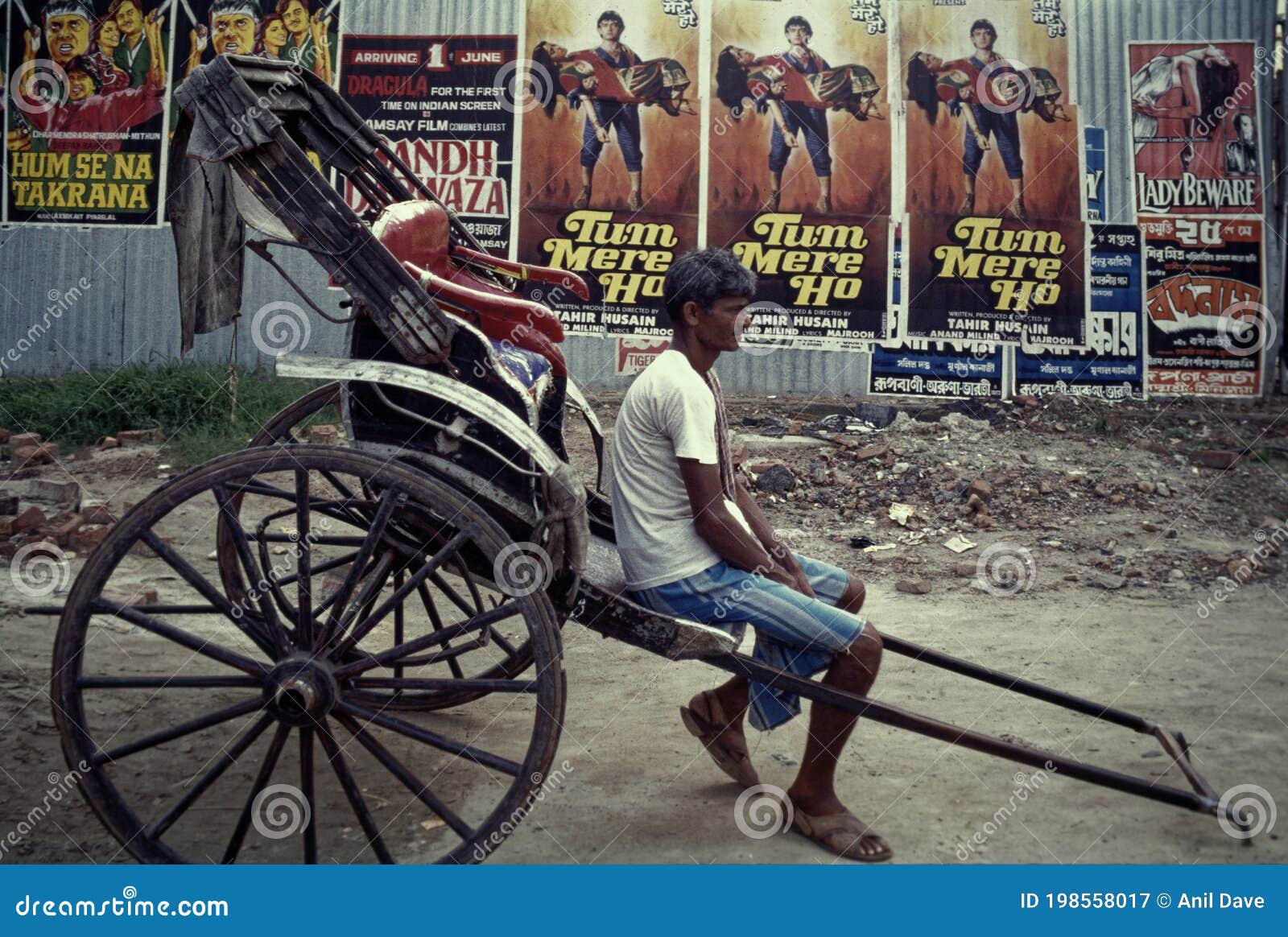 A Rickshaw Puller Waits for Passengers at a Roadside in Kolkata West ...