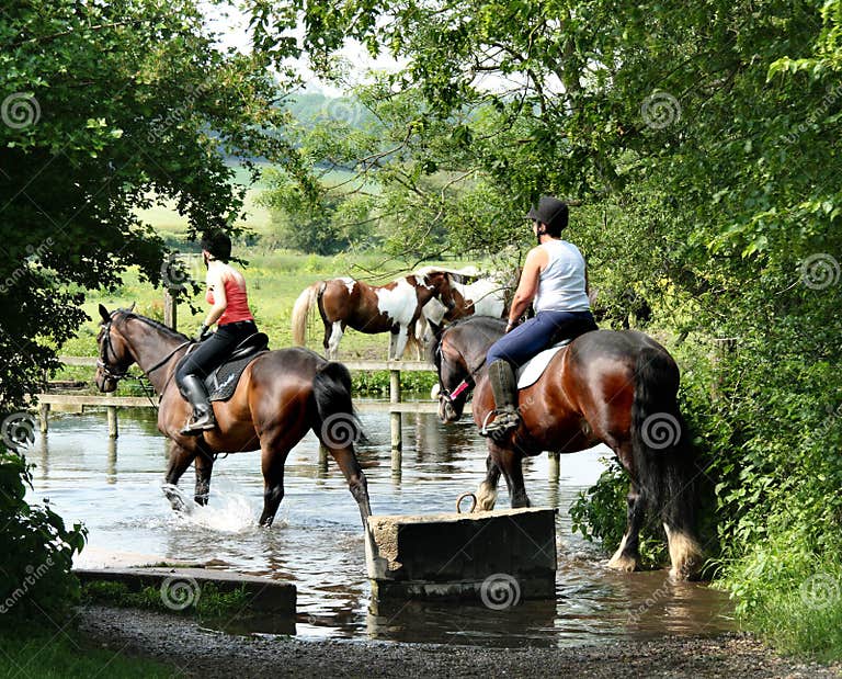 Riders Crossing a River stock image. Image of fitness - 2536867