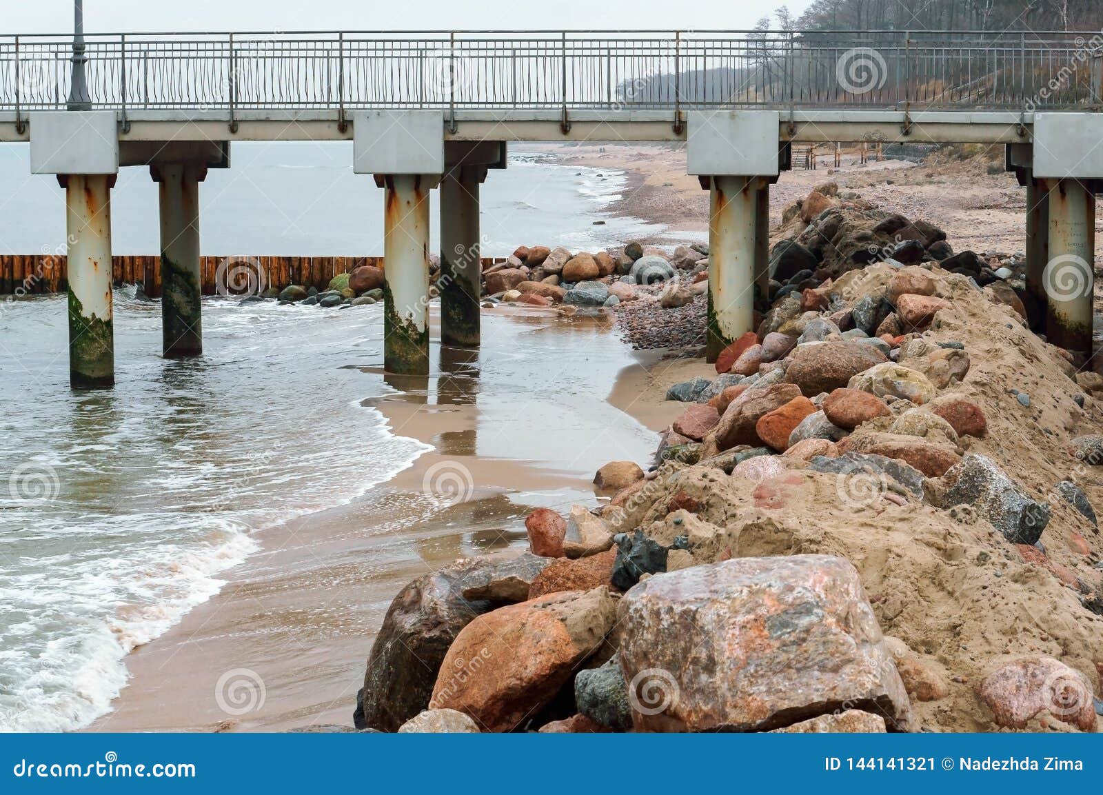 A Ridge of Boulders on the Beach, Pier on the Sea Stock Image - Image ...