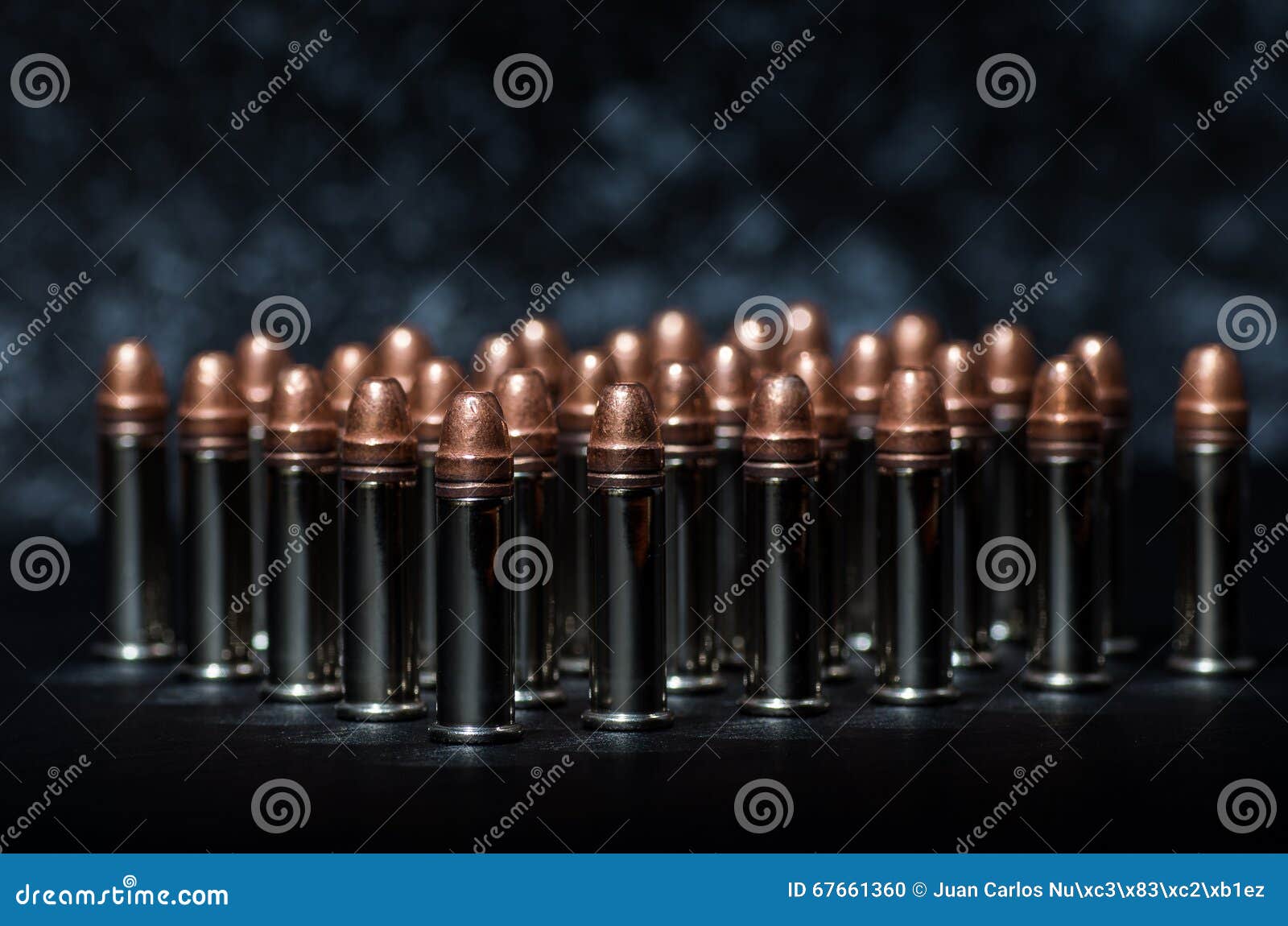 Rifle bullets over table stock photo. Image of guns, weapon - 67661360