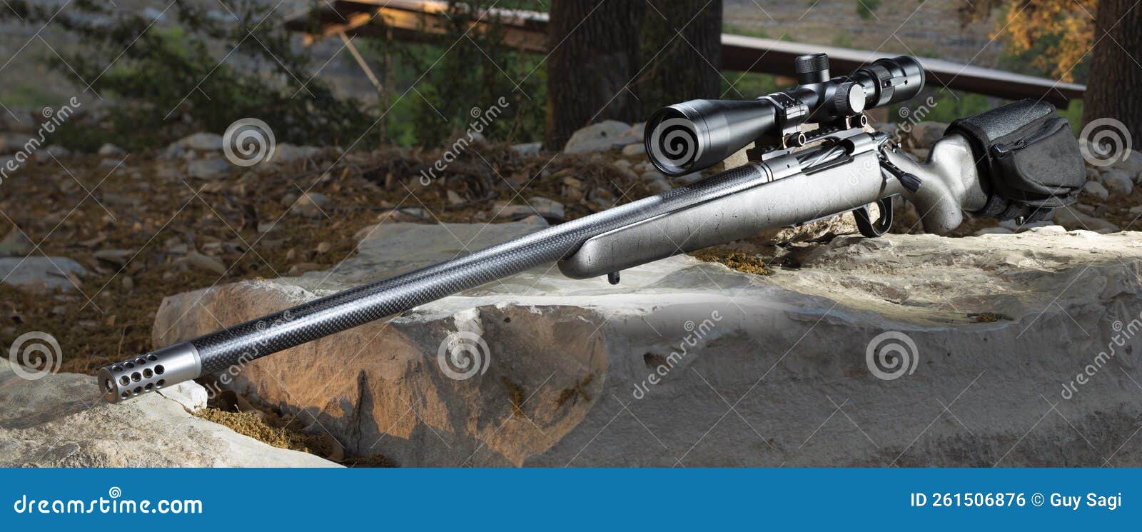 Rifle with scope on rocks stock photo. Image of dusk - 261506876