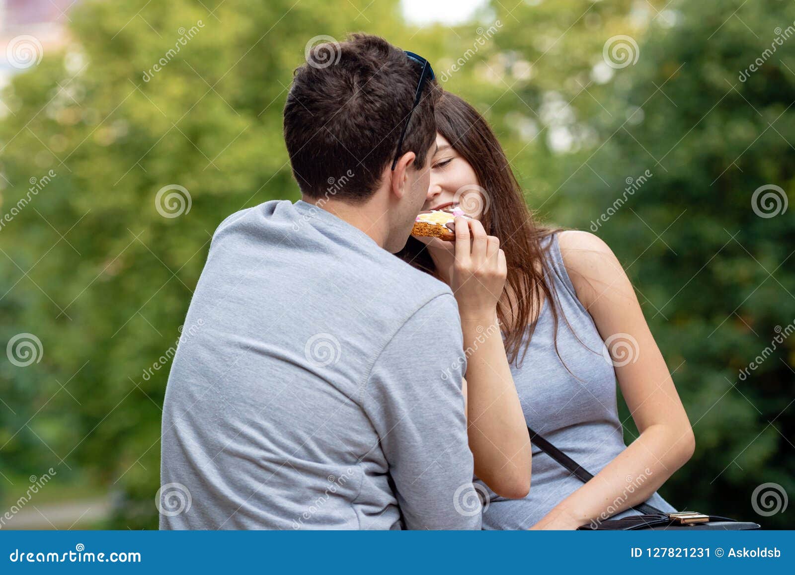 RIGA, LATVIA - AUGUST 18, 2018: a Couple of Young People Both Eat One ...
