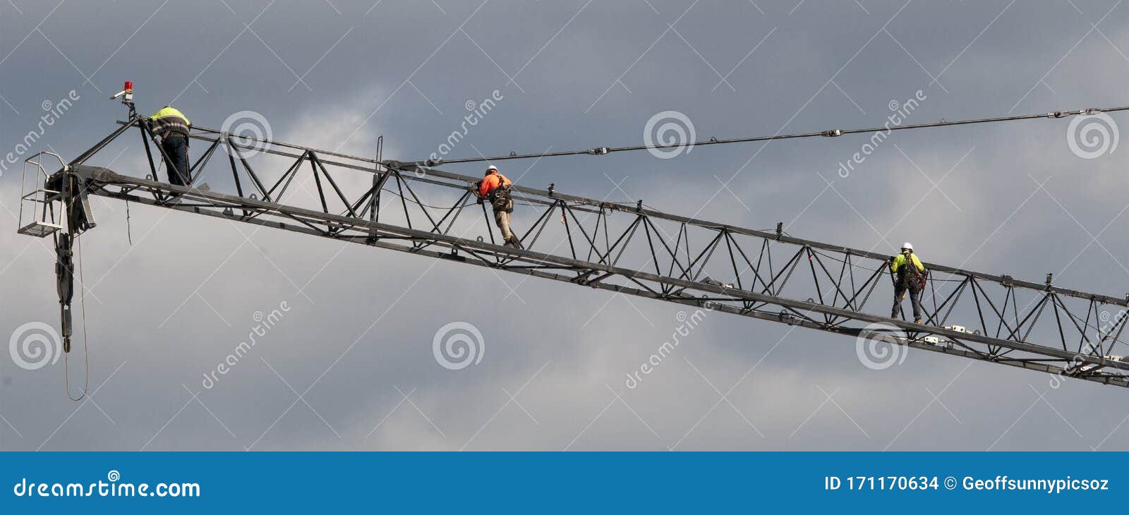 Riggers Up High Assembling and Erecting a Construction Tower Crane ...