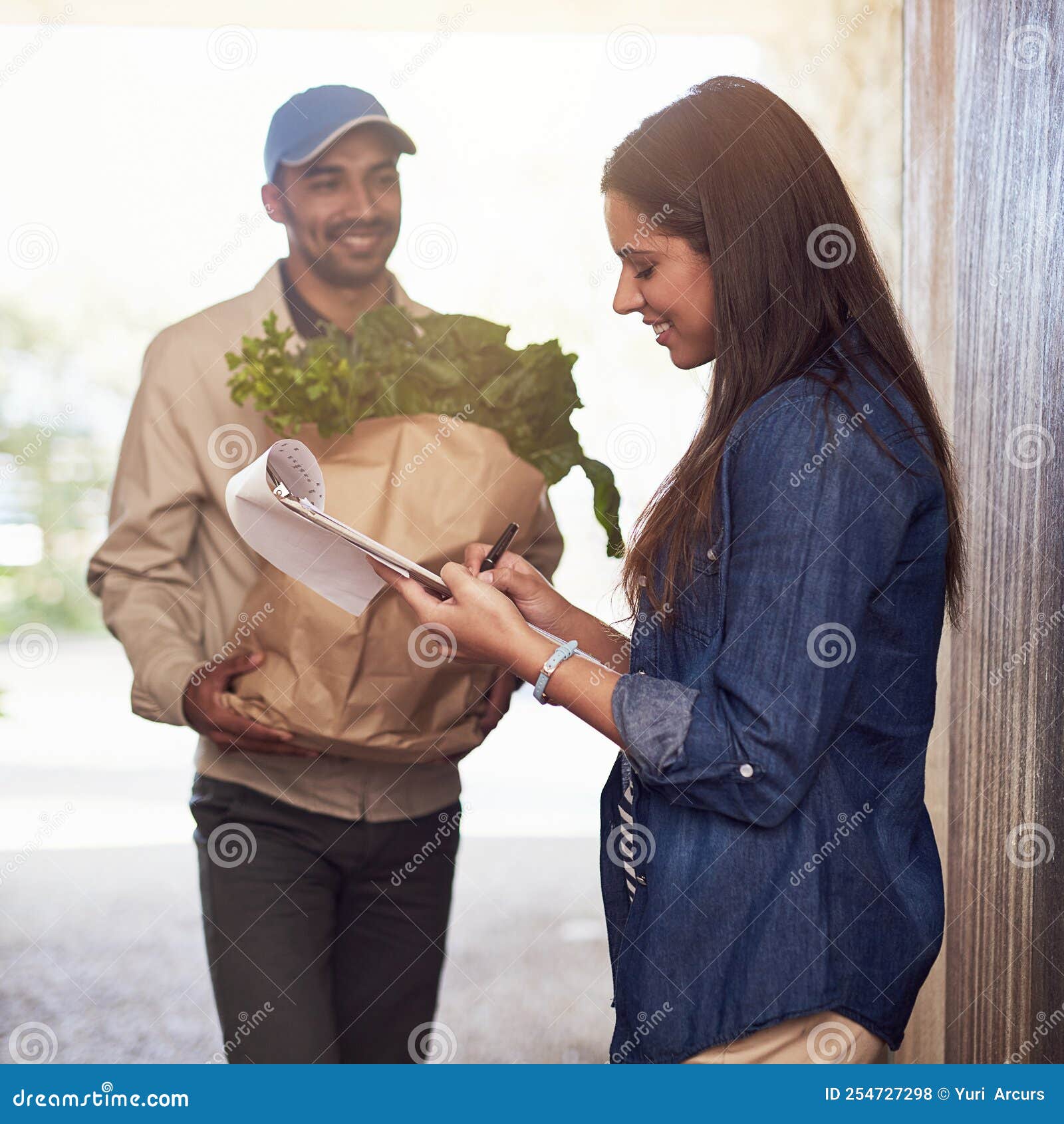 Right on Time. a Courier Making a Delivery To a Customer at Her Home ...