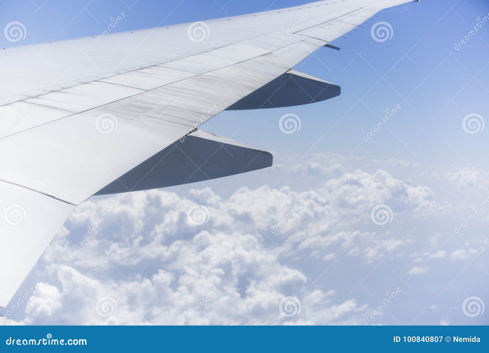 Right Wing of an Aircraft with Rear Engine and Blue Sky at Background ...
