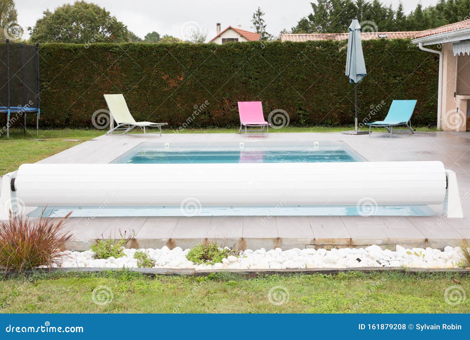 Rigid Cover Rolls Over an Outdoor Swimming Pool Stock Photo - Image of ...