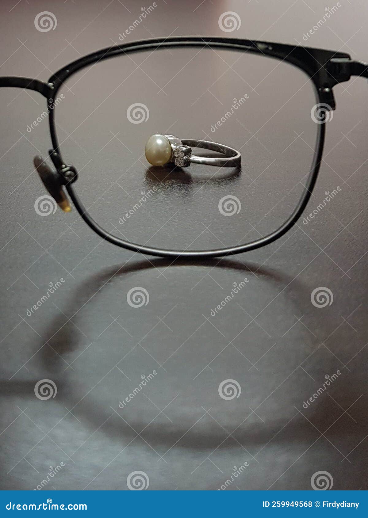 Ring in frame in glasses stock photo. Image of necklace - 259949568