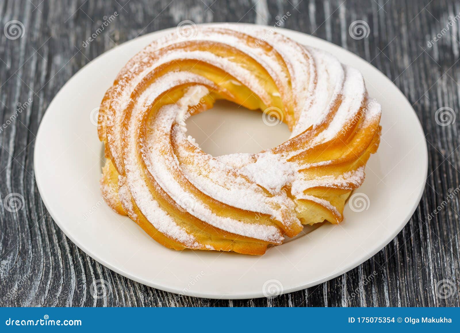 Ring-shaped Eclair Cakes with Sugar Powder and Cream Stock Photo ...