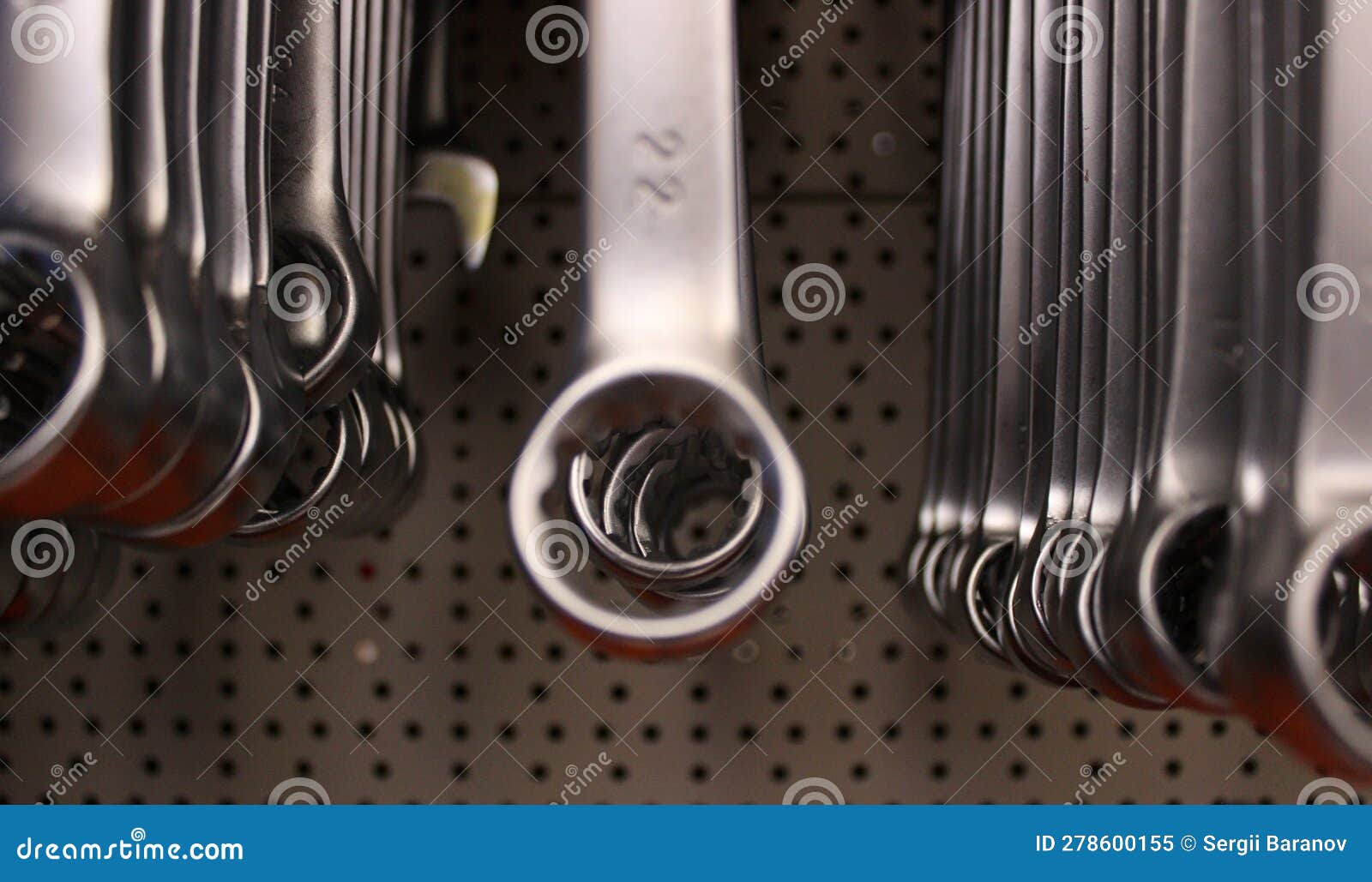 Ring Side of Combination Wrenches in Front of Perforated Metal Sheet ...
