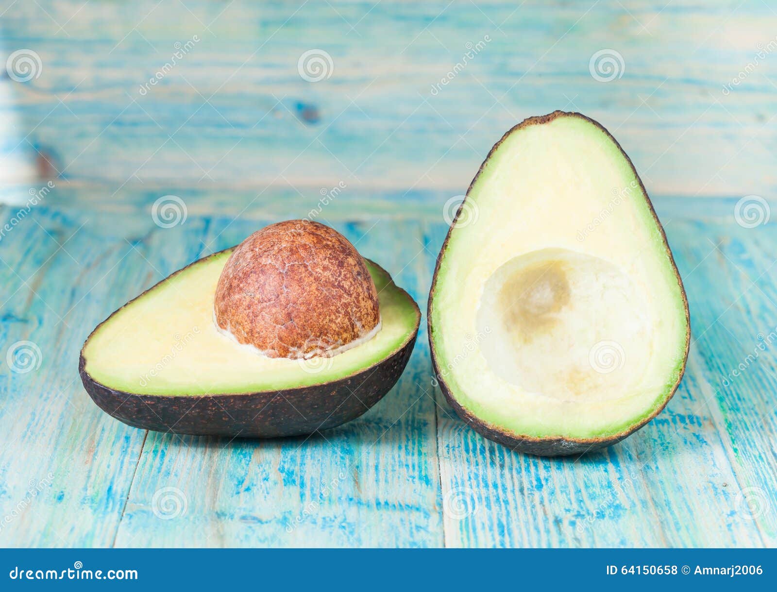 Ripe Avocado Cut in Half on a Wooden Stock Photo - Image of tropical ...