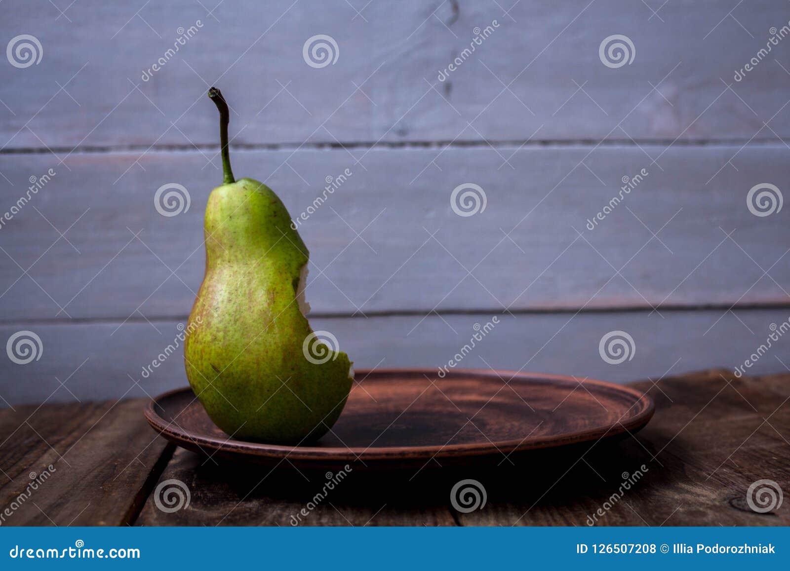 A Bite Pear on a Plate on Wooden Background Stock Photo - Image of food ...