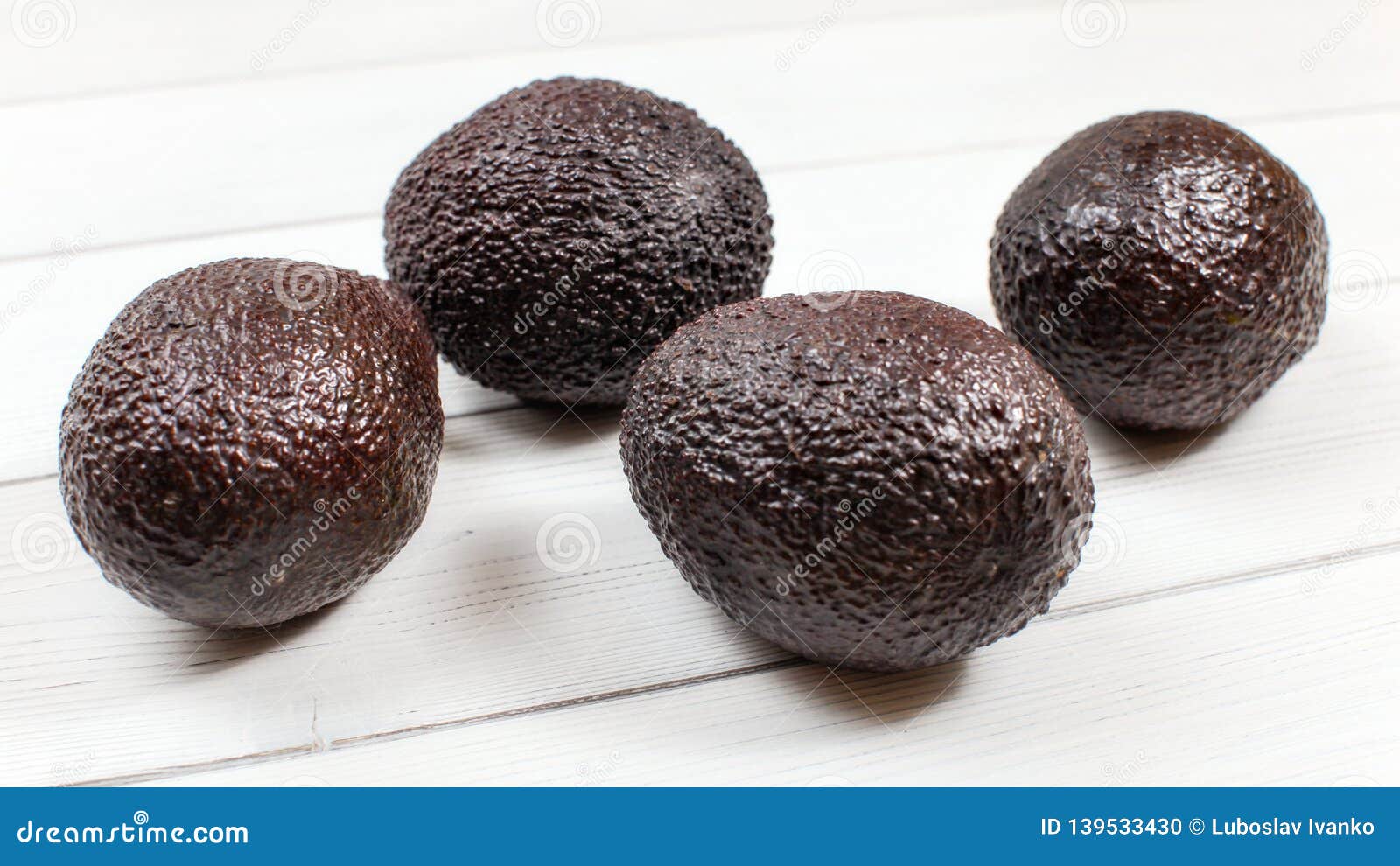 Ripe Dark Brown Avocados on White Board Stock Photo - Image of brown ...