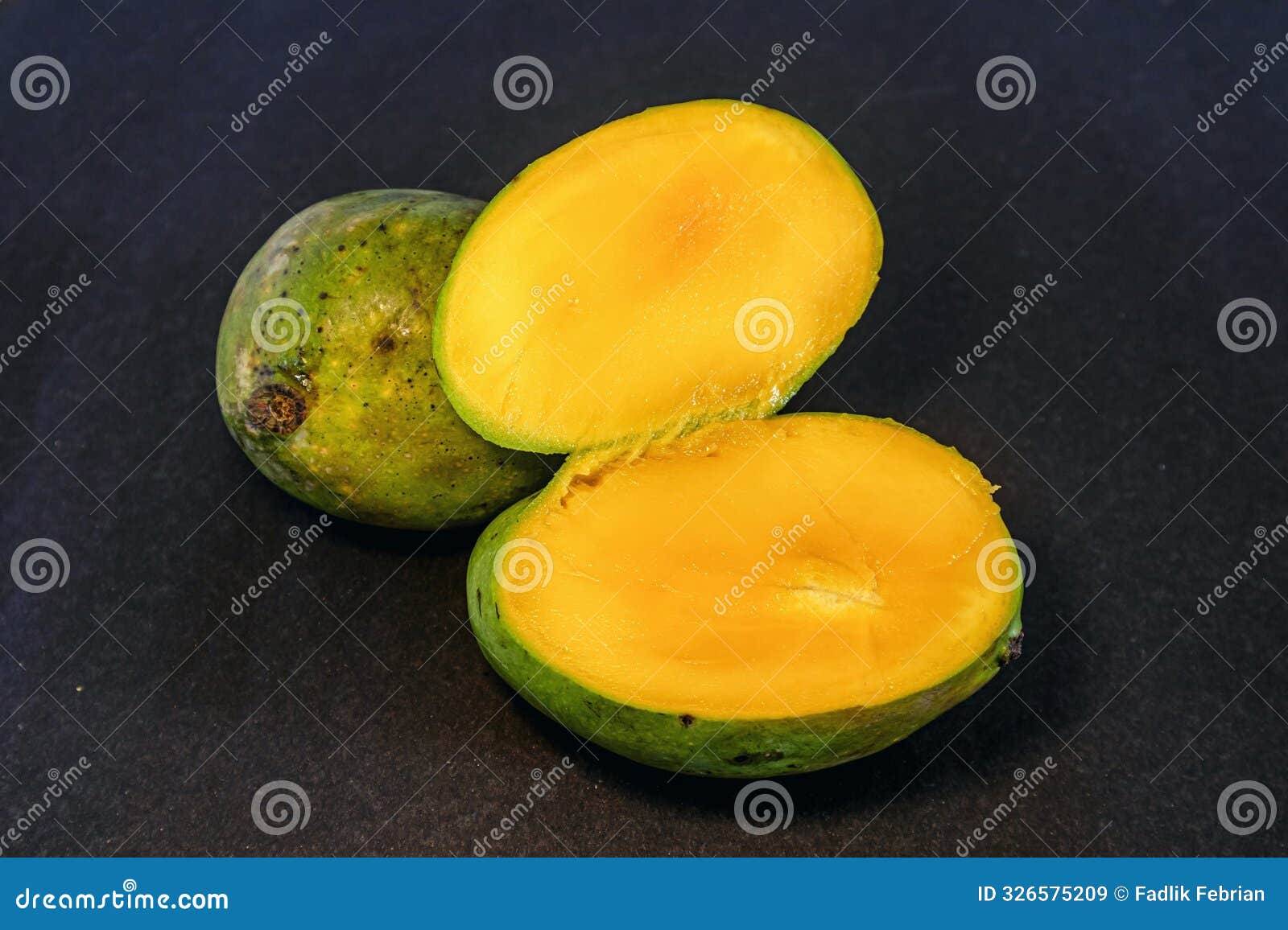 Ripe Local Indonesian Mango with Cut in Half Isolated on Dark ...