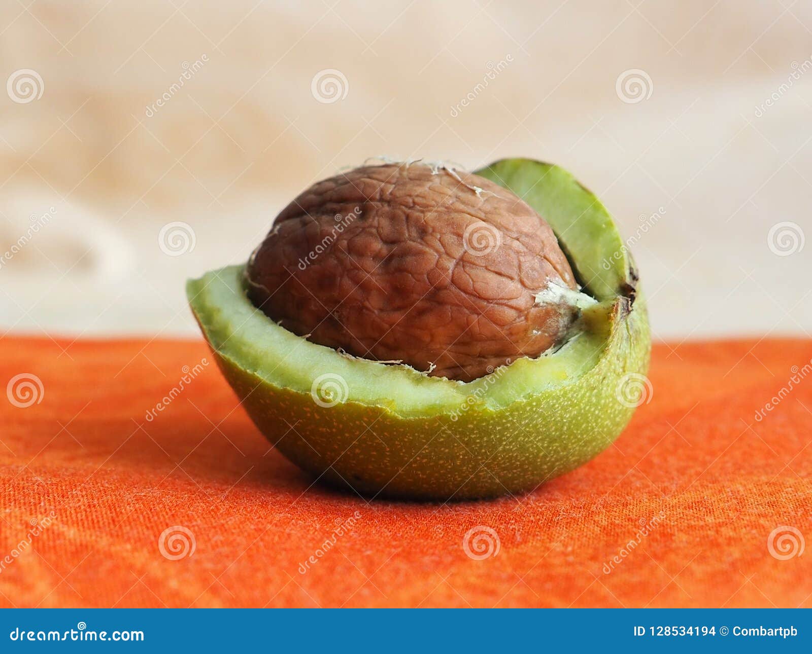 Ripe Nut with an Open Green Shell on the Orange Table. a Clear Walnut ...