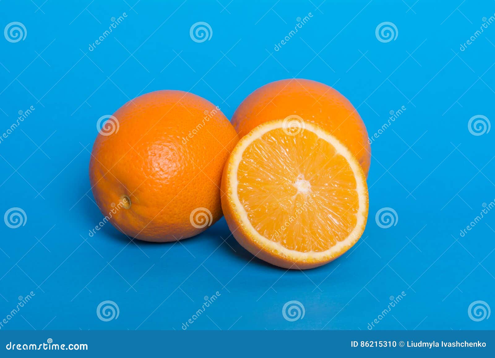 Ripe Oranges on a Blue Background. Juicy Half Orange. Stock Photo ...