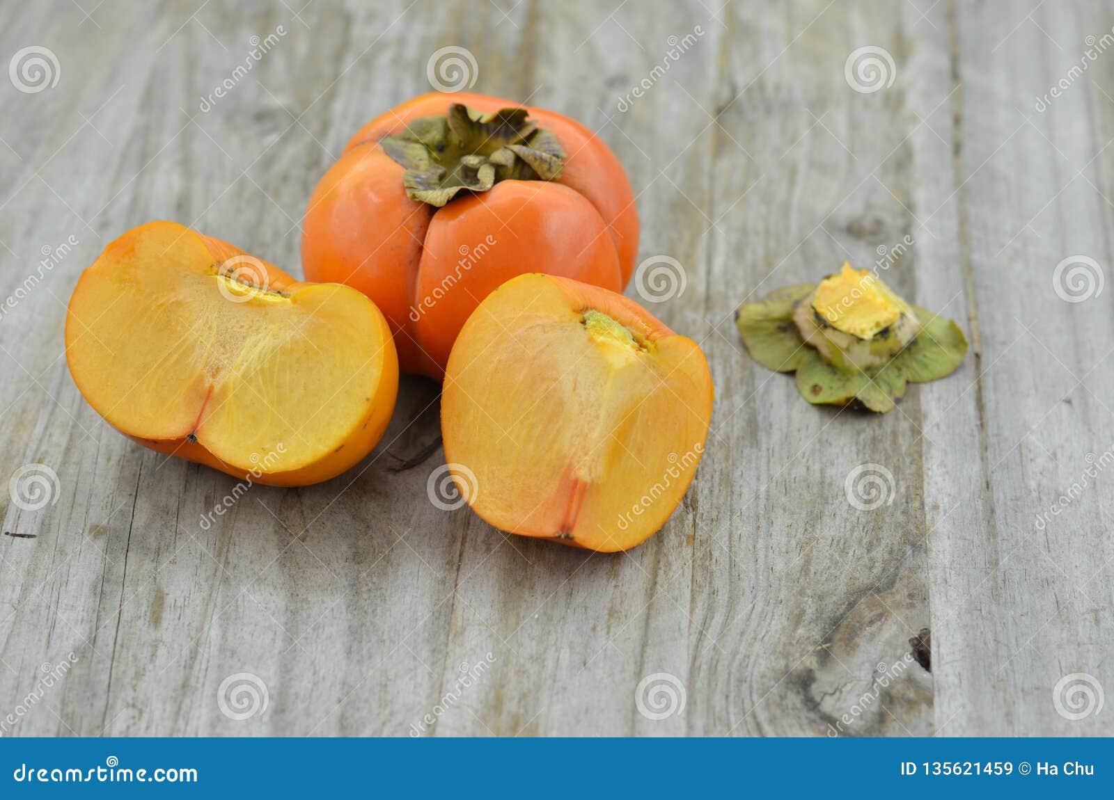 Ripe Persimmons Cut Half on Wooden Background Stock Image - Image of ...