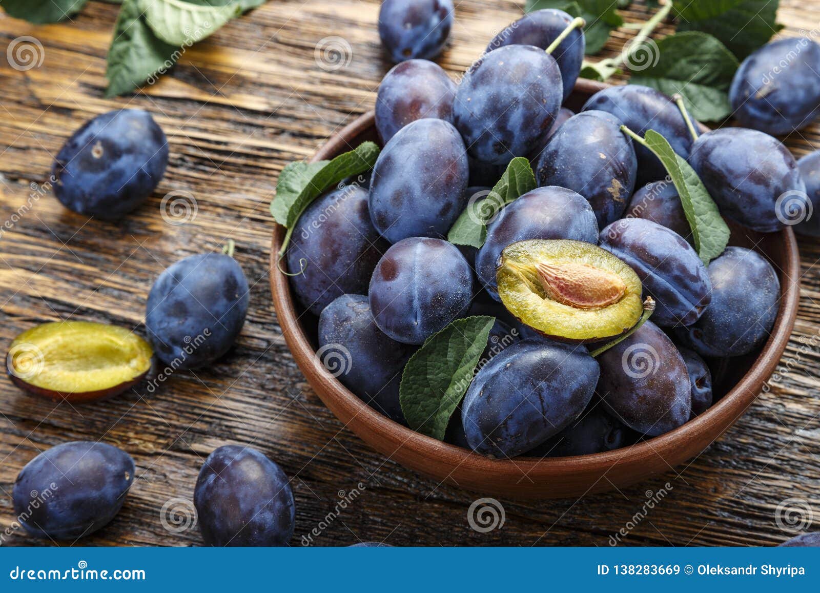 Ripe Plums in Plate on a Dark Brown Wooden Table Stock Image - Image of ...