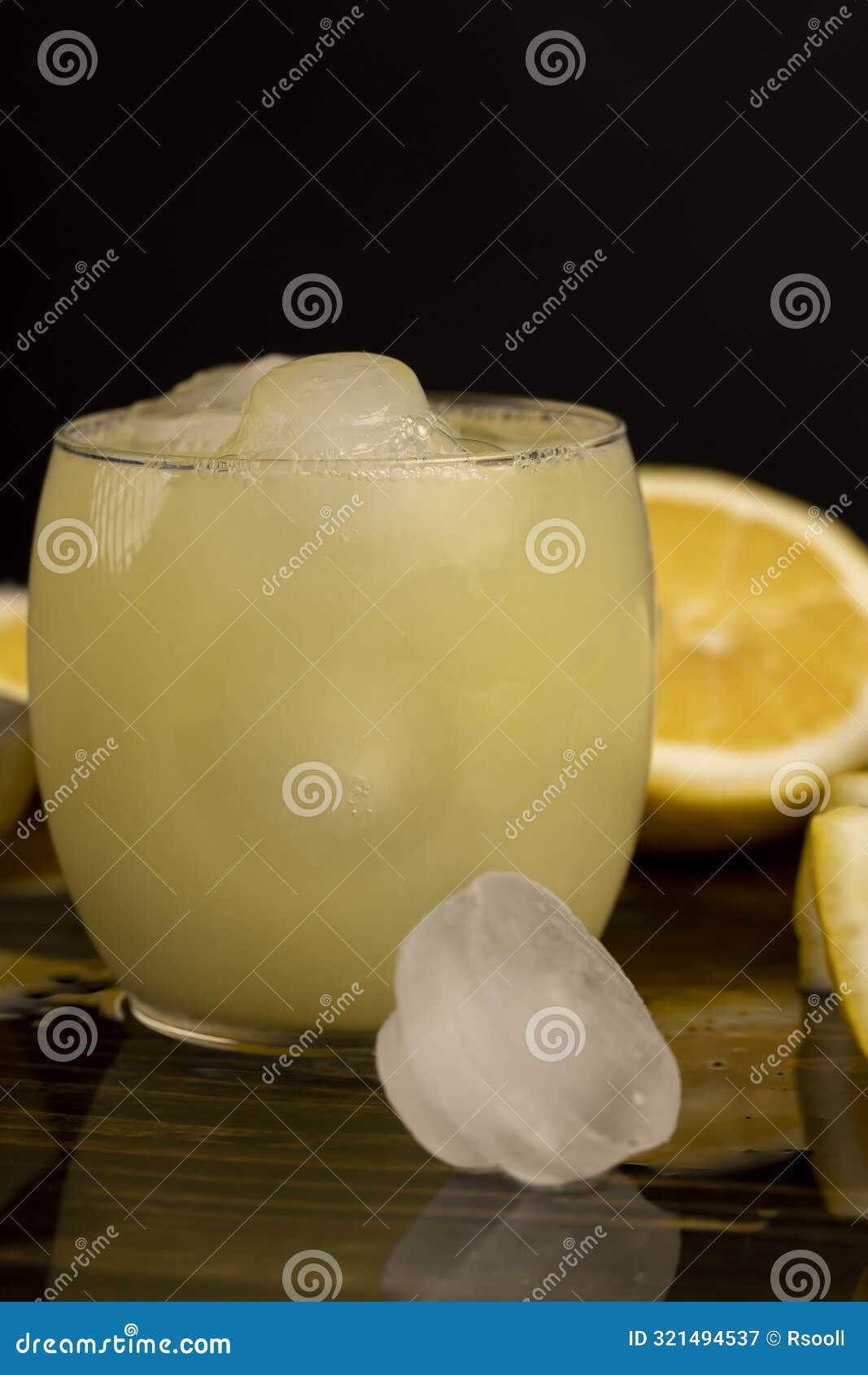 Ripe Sliced Lemon and Cold Juice with Ice and Their Reflection on a Wet ...