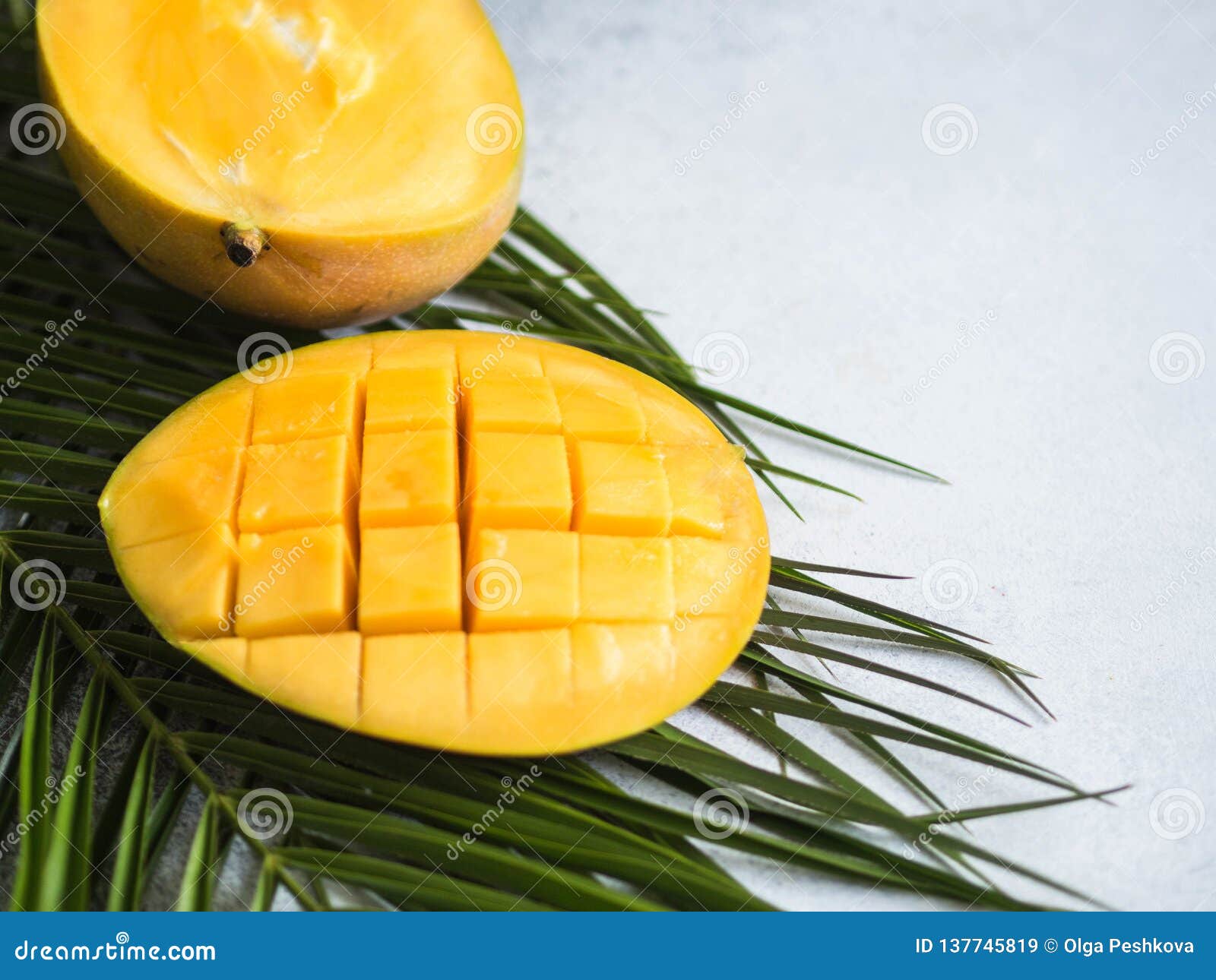Ripe Yellow Mango Slice on Palm Tree Leaves on Gray Background. Copy ...