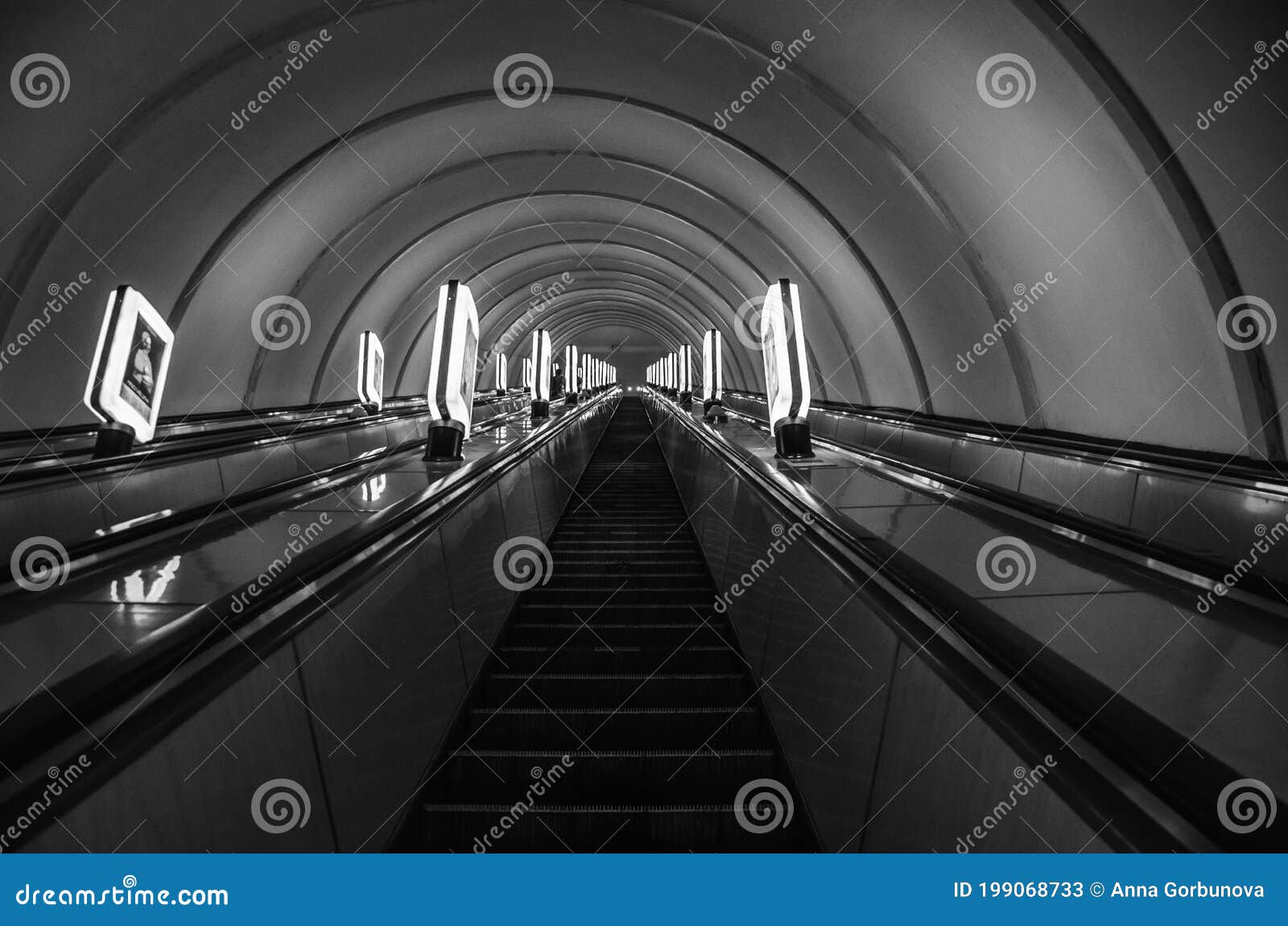 Rise on the Escalator in the Subway. Light Boxes Along the Tunnel Stock ...