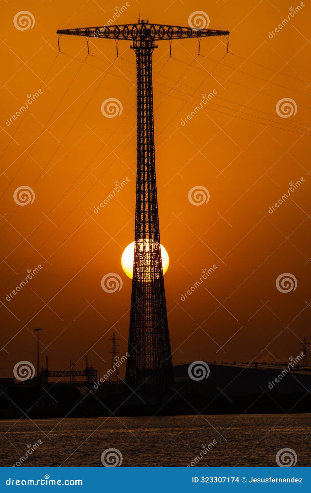 Rising sun behind pylon stock photo. Image of nature - 323307174