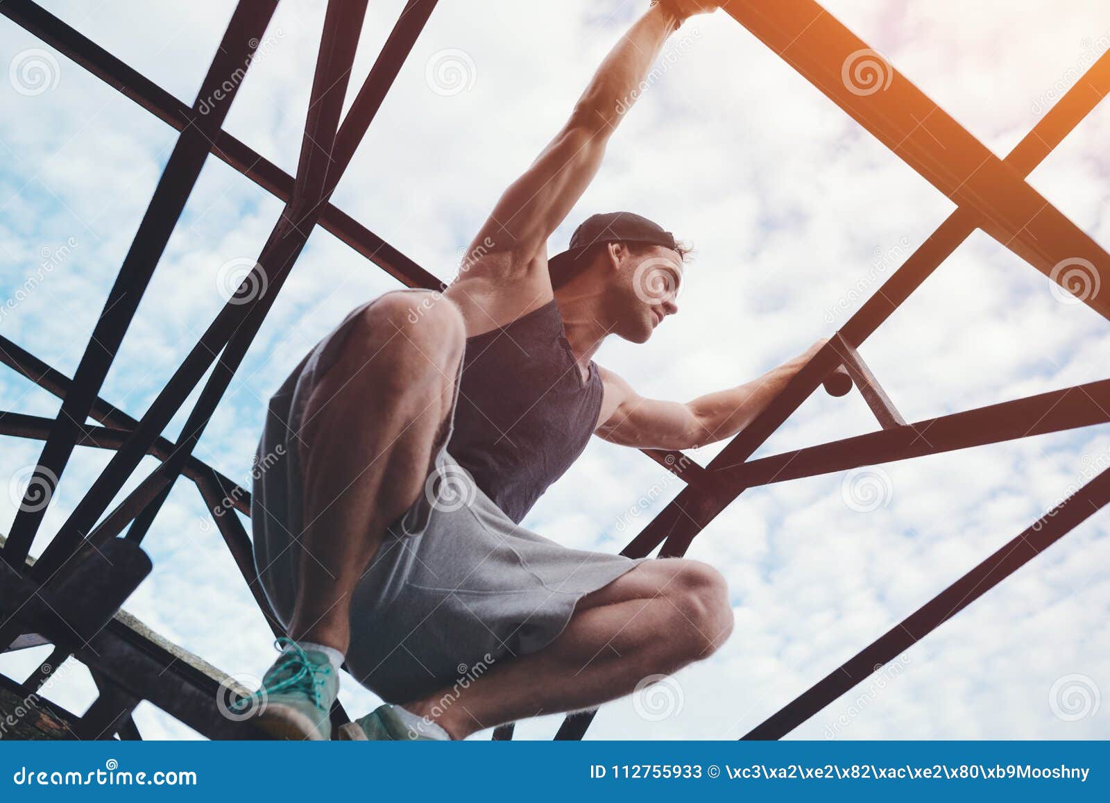 Risky Brave Man Climbing and Sitting on High Metal Bridge Stock Image ...